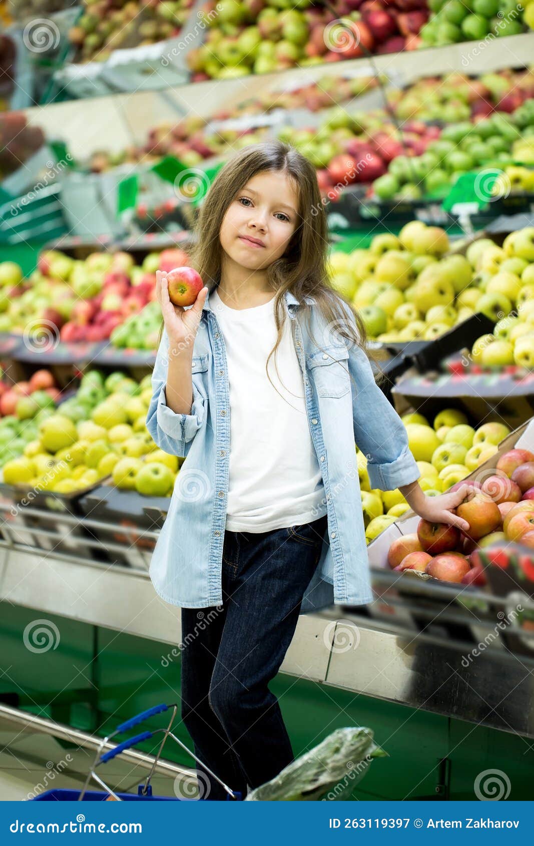 Little Girl Choosing a Bio Apple in a Store. Stock Image - Image of ...