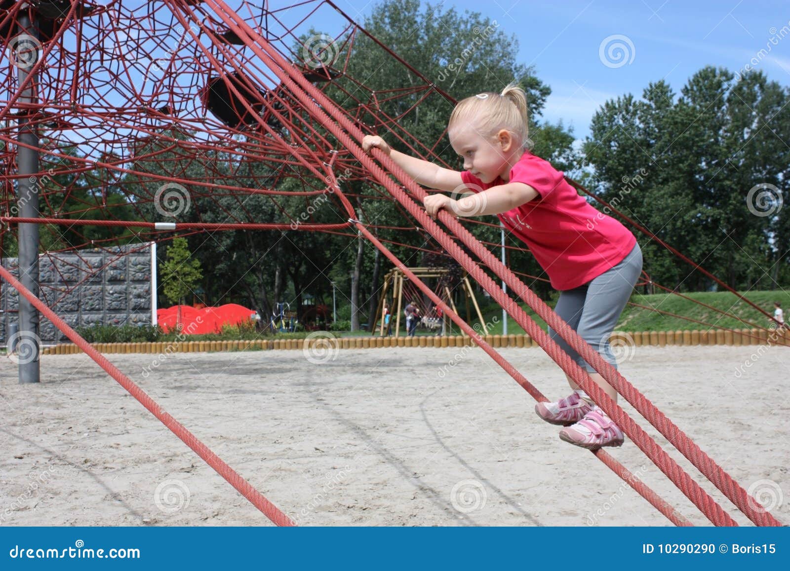 Little Girl Climbing through the Web of Ropes Stock Photo - Image of ...