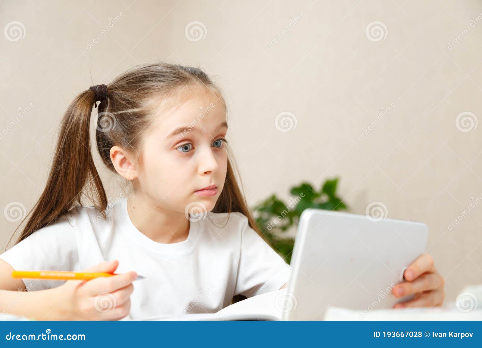Little Girl Doing Homework at Home at the Table. the Child is Home ...