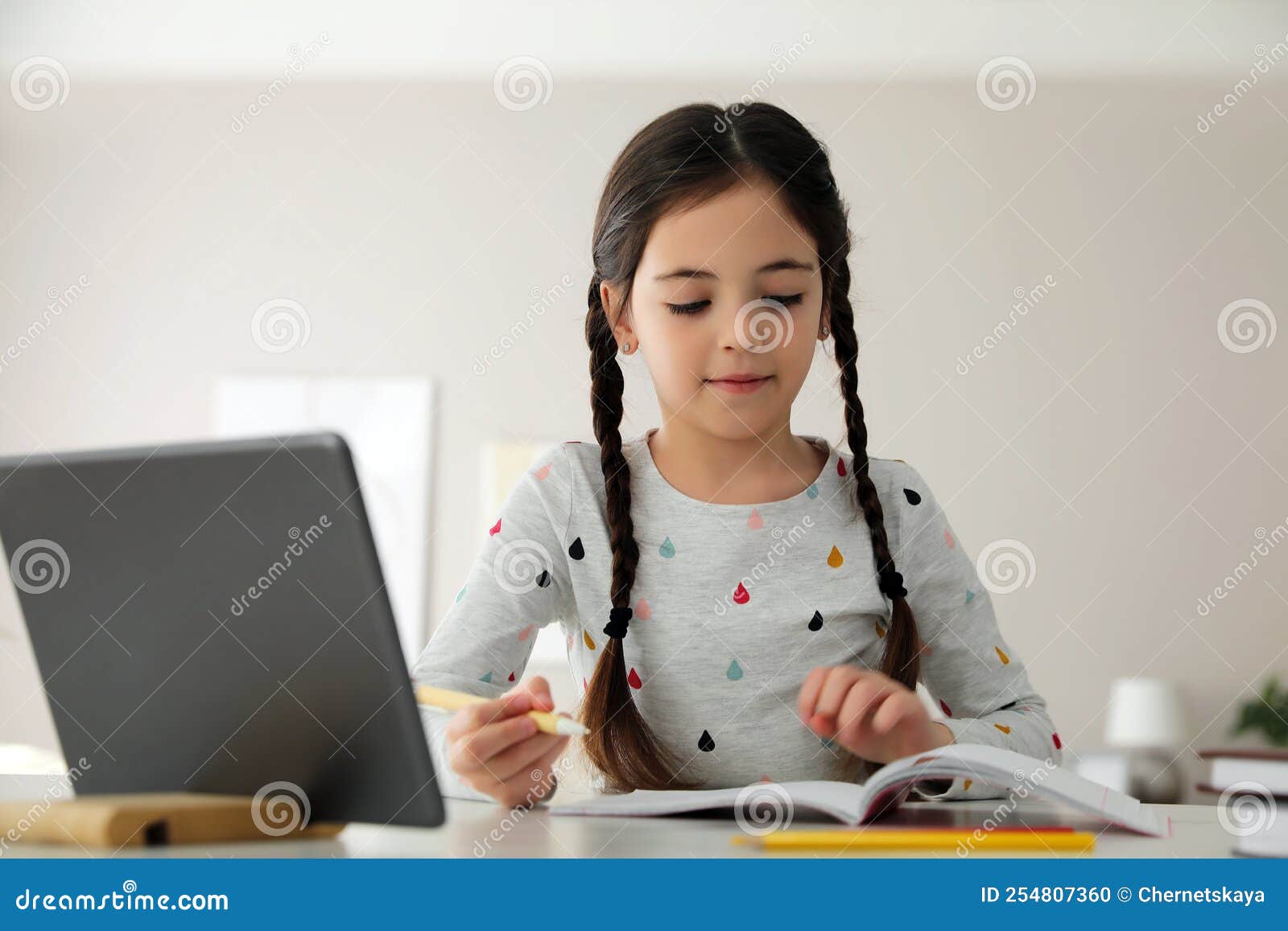Little Girl Doing Homework with Modern Tablet at Home Stock Photo ...