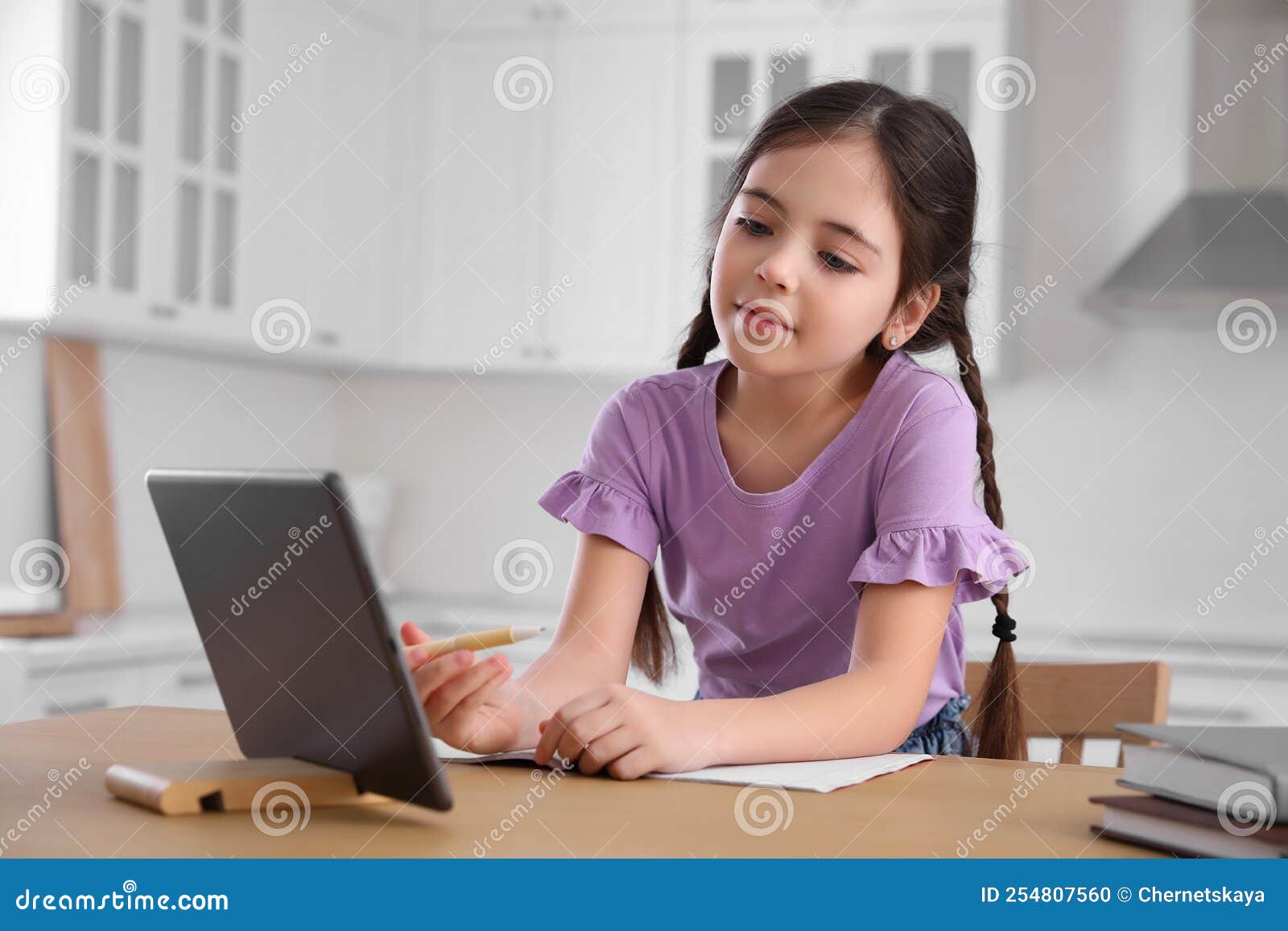 Little Girl Doing Homework with Tablet at Home Stock Photo - Image of ...