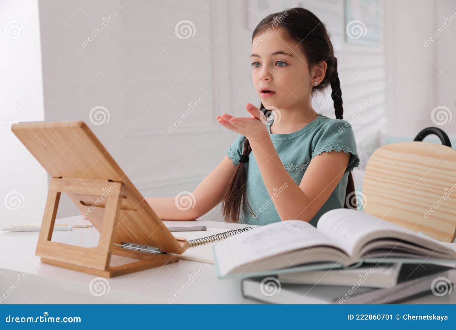 Little Girl Doing Homework with Tablet at Table in Room Stock Image ...