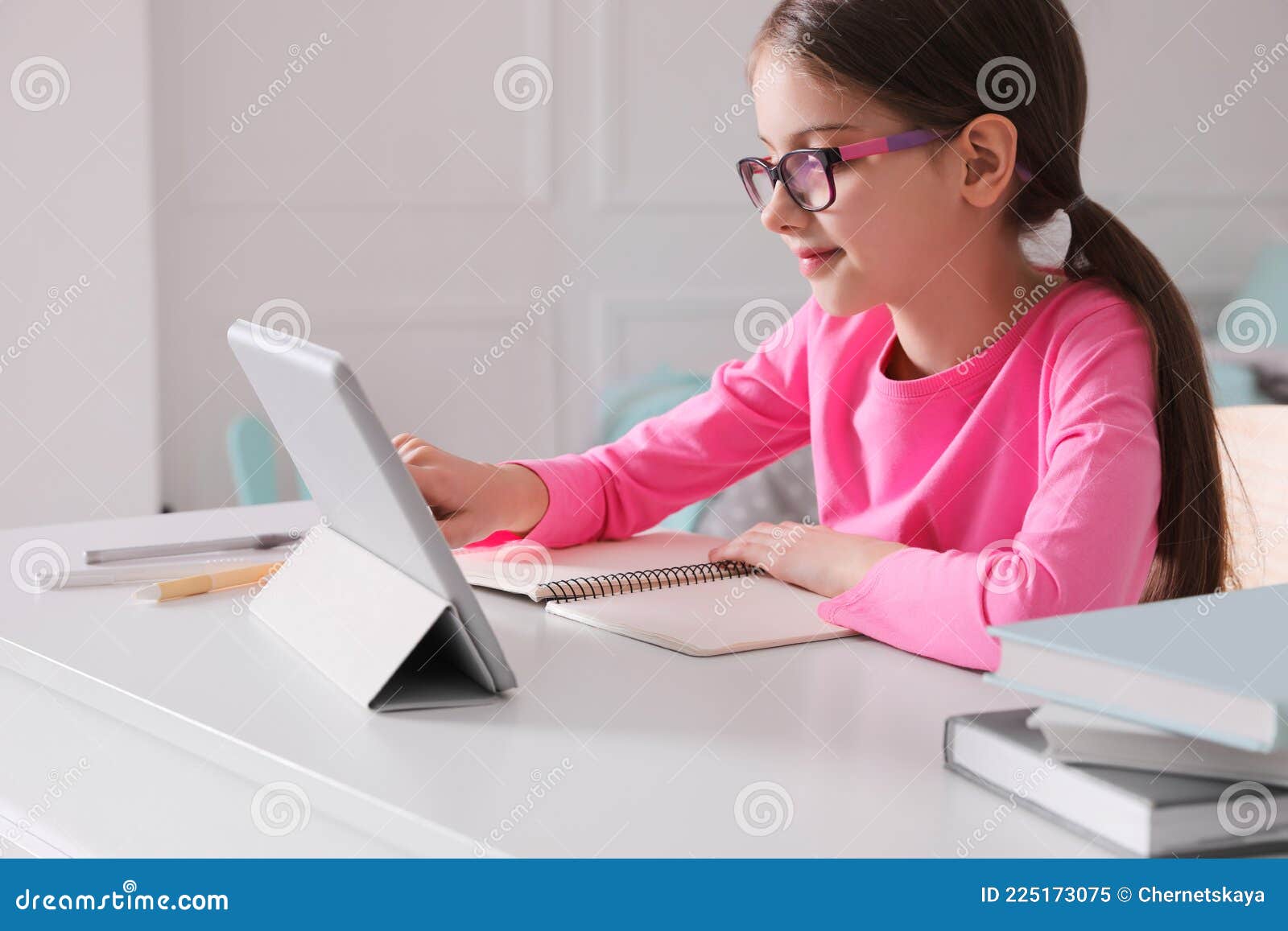 Little Girl Doing Homework with Tablet at Table Stock Image - Image of ...