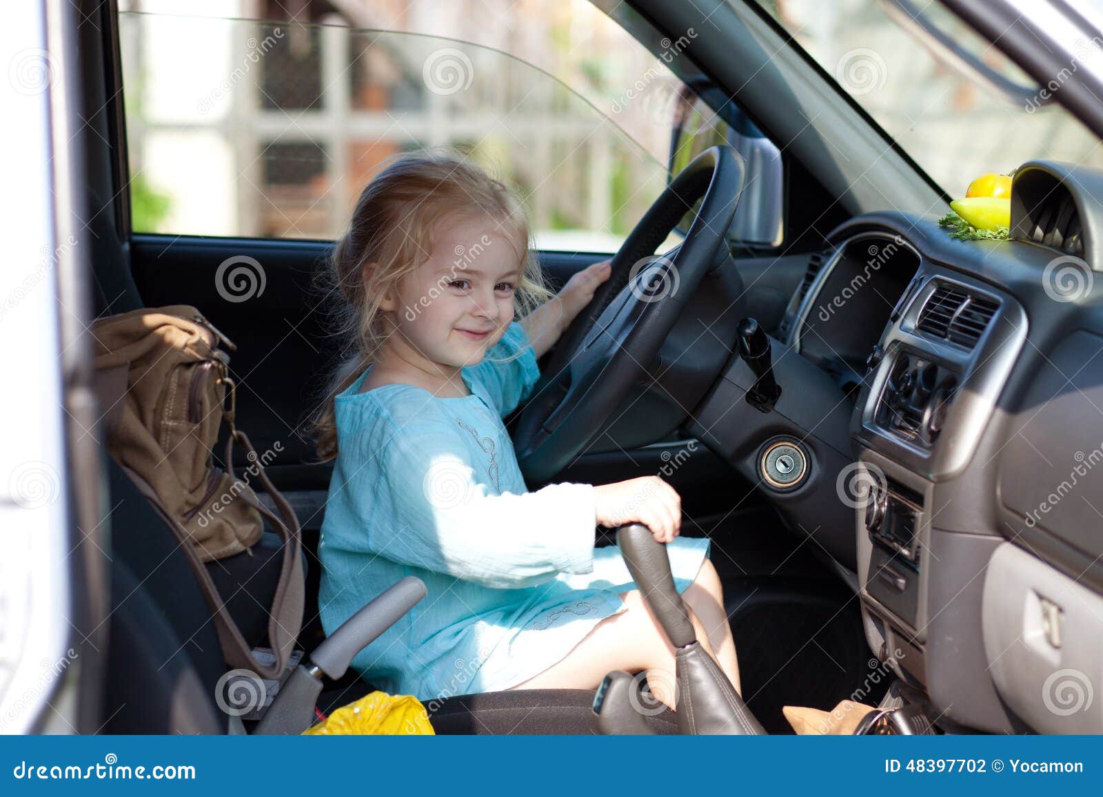 Little girl driving a car stock photo. Image of steering - 48397702