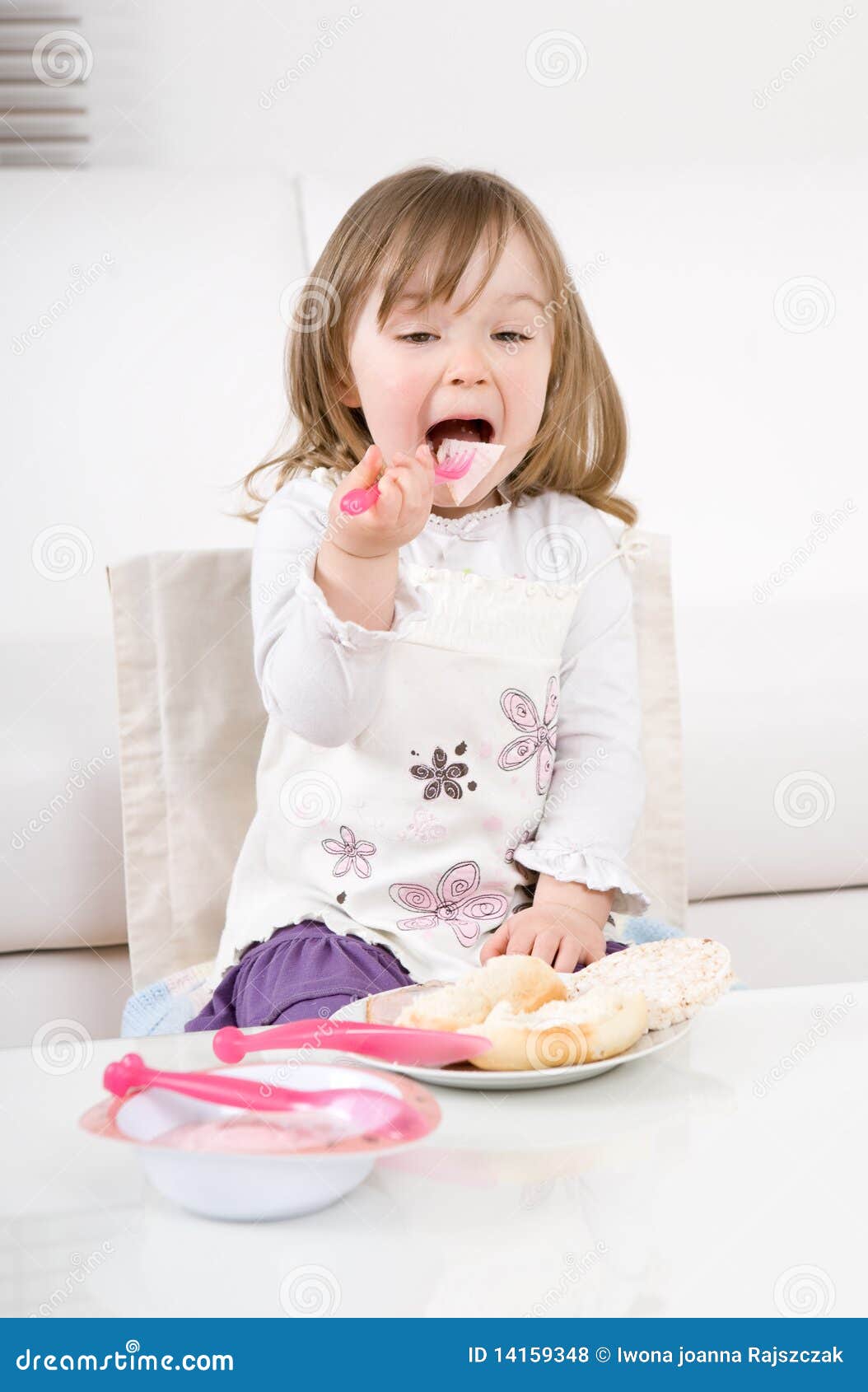 Little girl eating stock photo. Image of happiness, family - 14159348