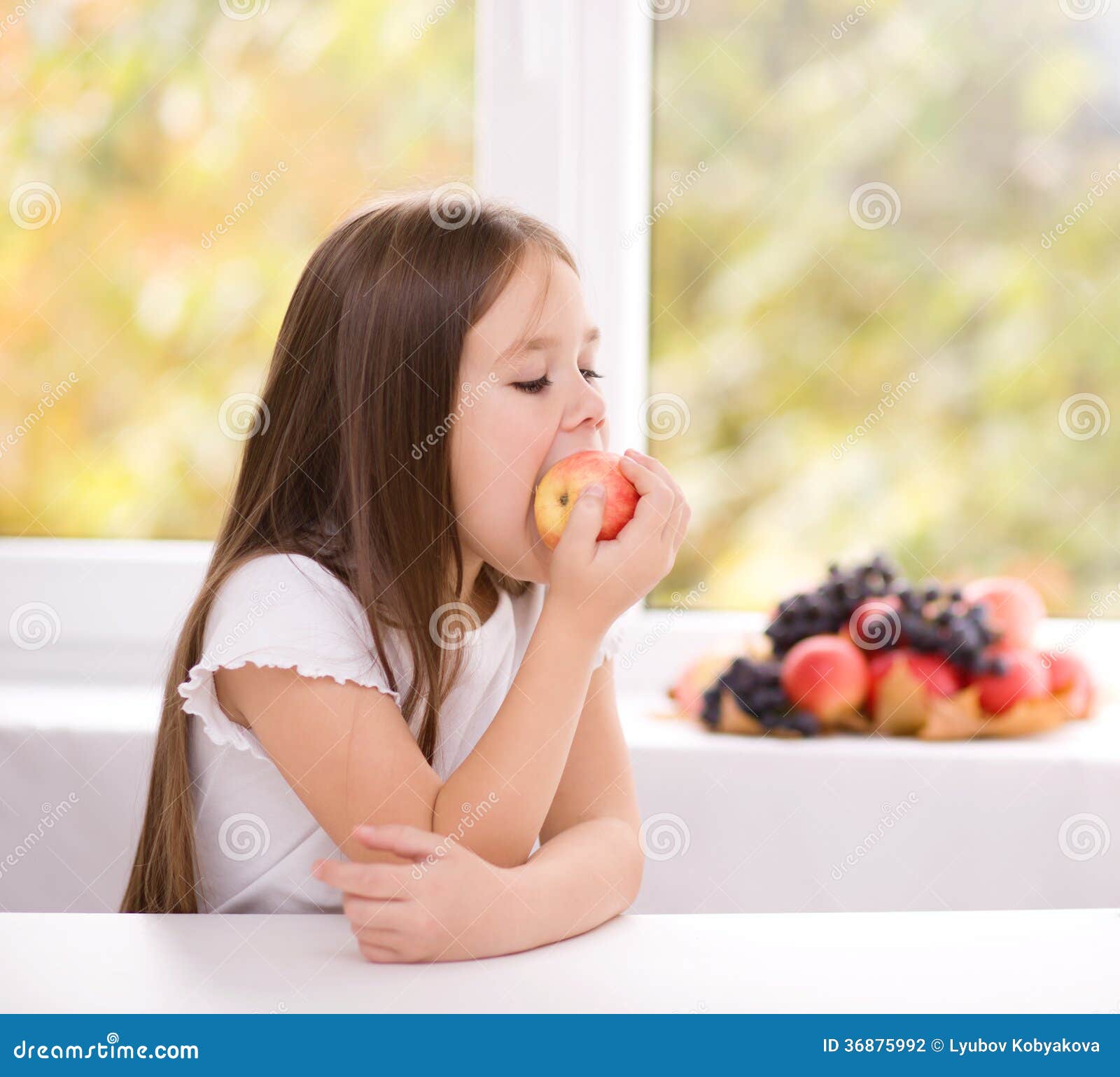 Little Girl Eating an Apple Stock Photo - Image of brunette, people ...
