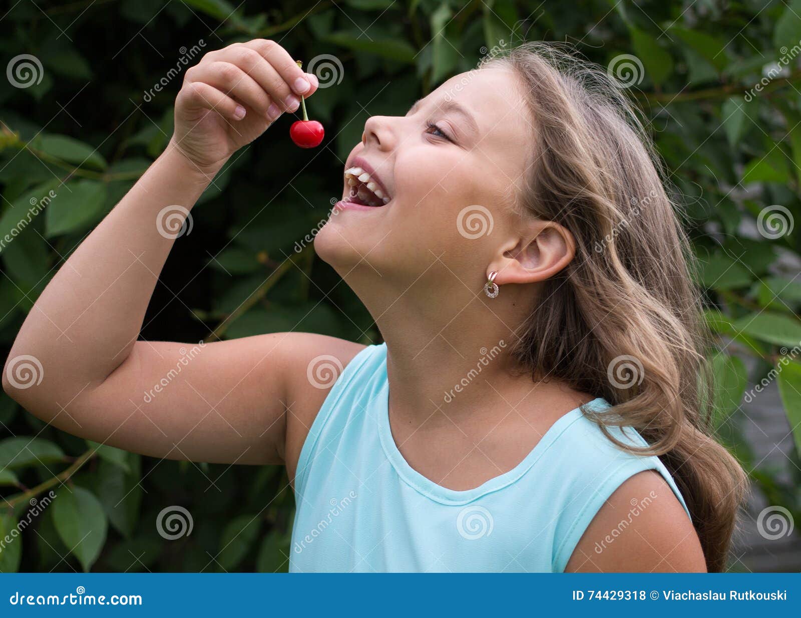 Little Girl Eating a Cherry Stock Photo - Image of pretty, green: 74429318