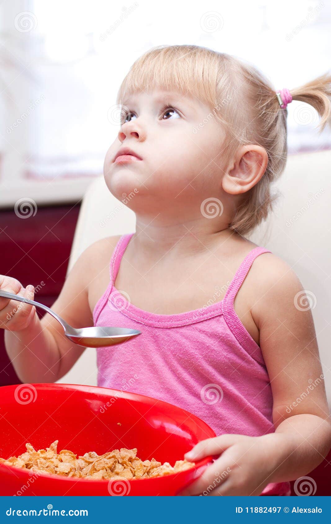Little girl eating flakes stock image. Image of child - 11882497