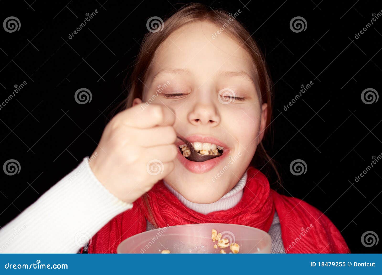 Little girl eating flakes stock image. Image of adorable - 18479255