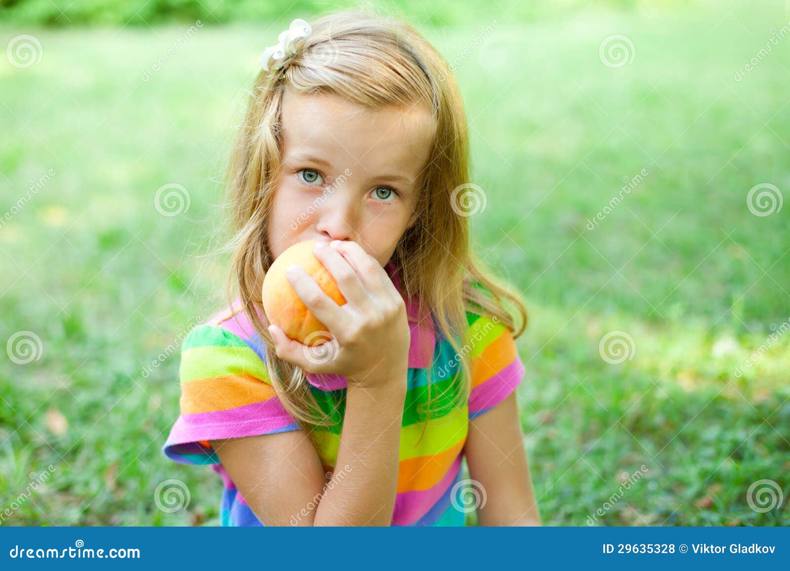 Little girl eating peach stock photo. Image of people - 29635328
