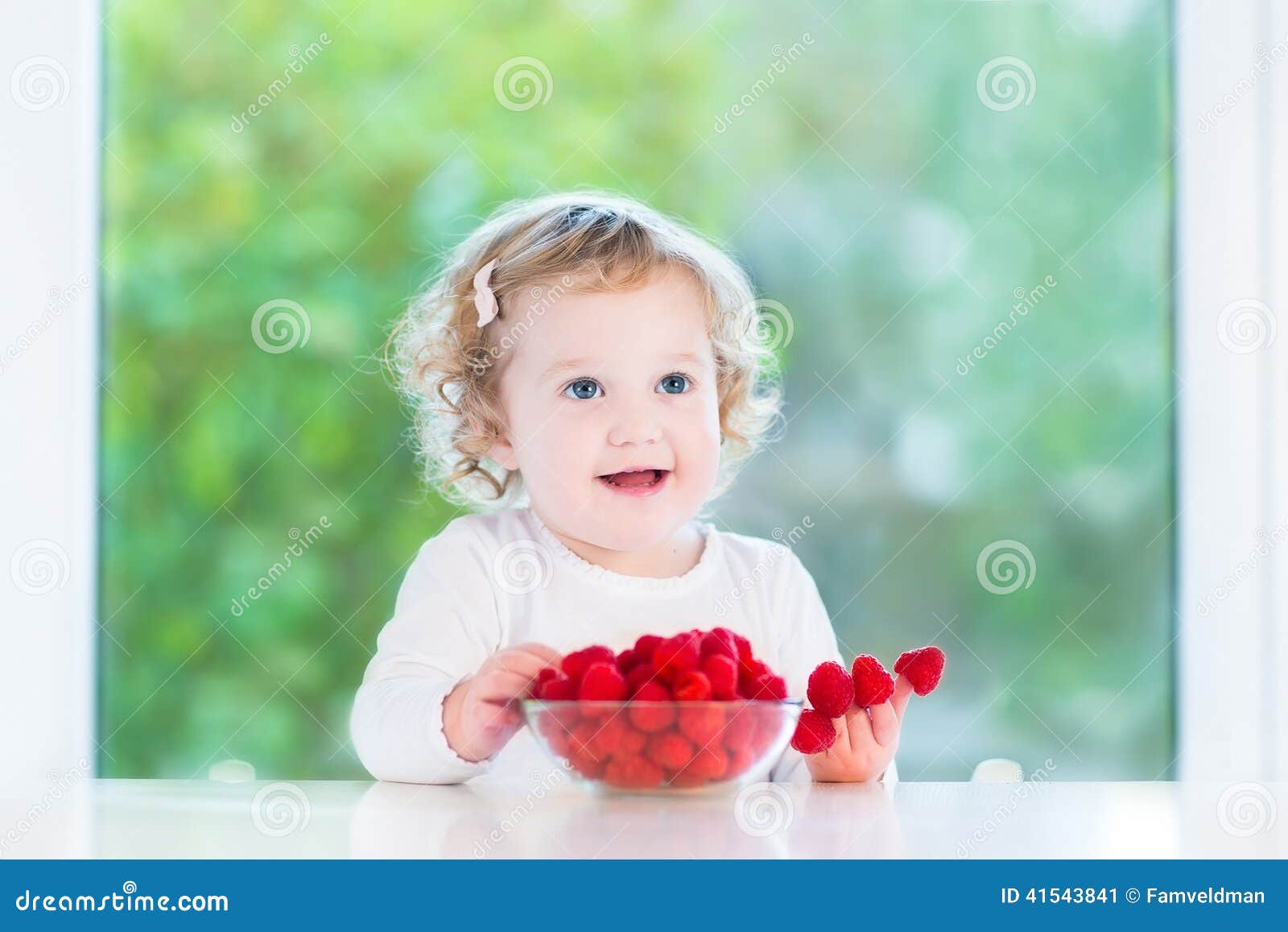 Little Girl Eating Raspberry White Dining Room Stock Photos - Free ...