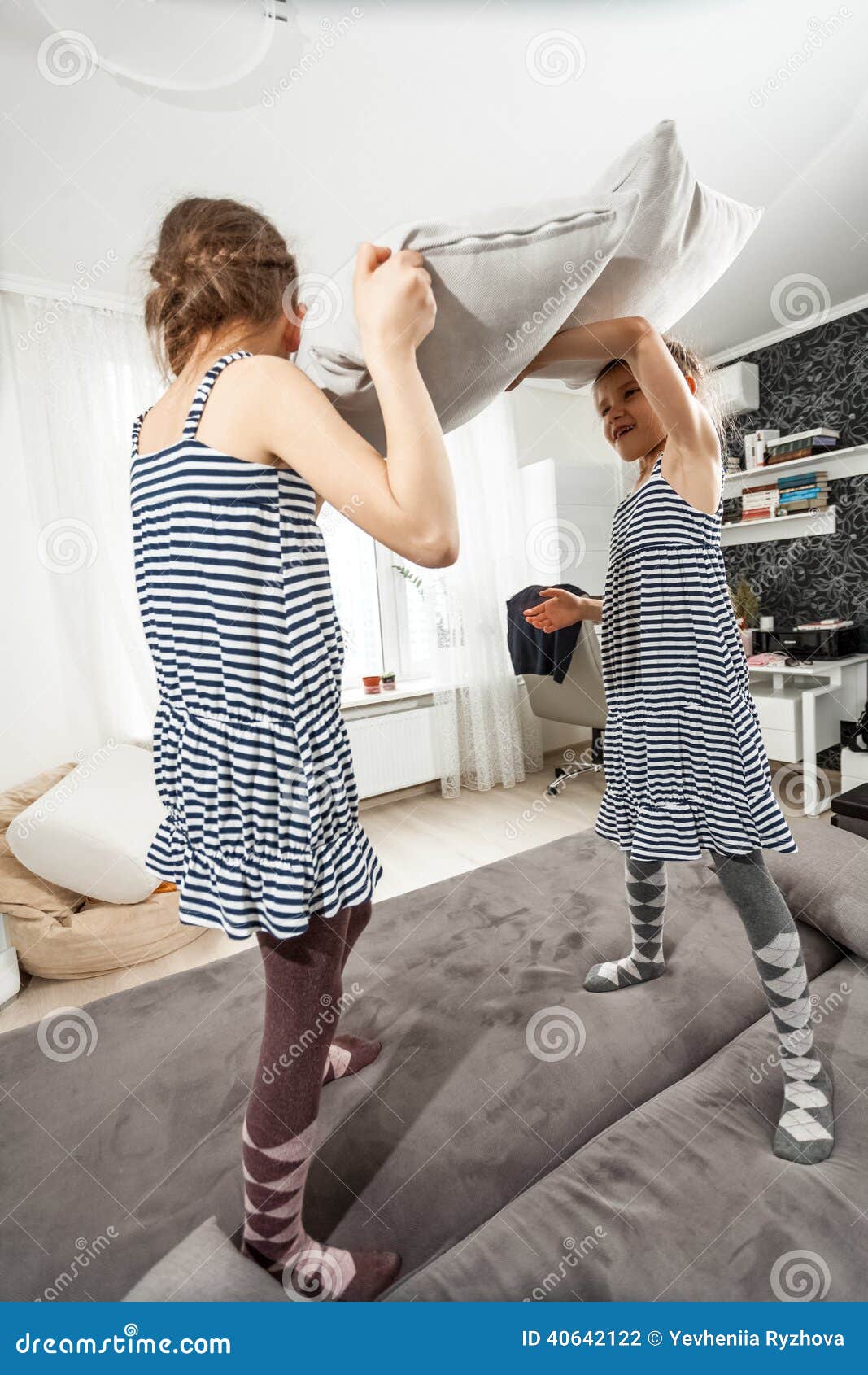 Little Girl Fighting with Pillows on Bed Stock Photo - Image of ...