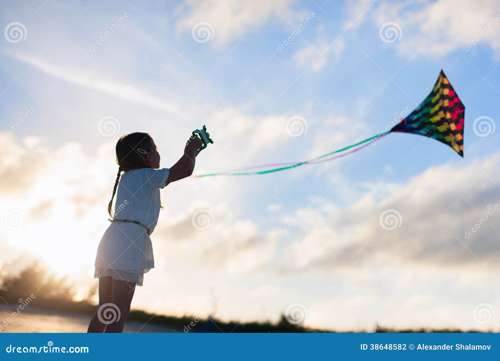 Little girl flying a kite stock photo. Image of silhouette - 38648582