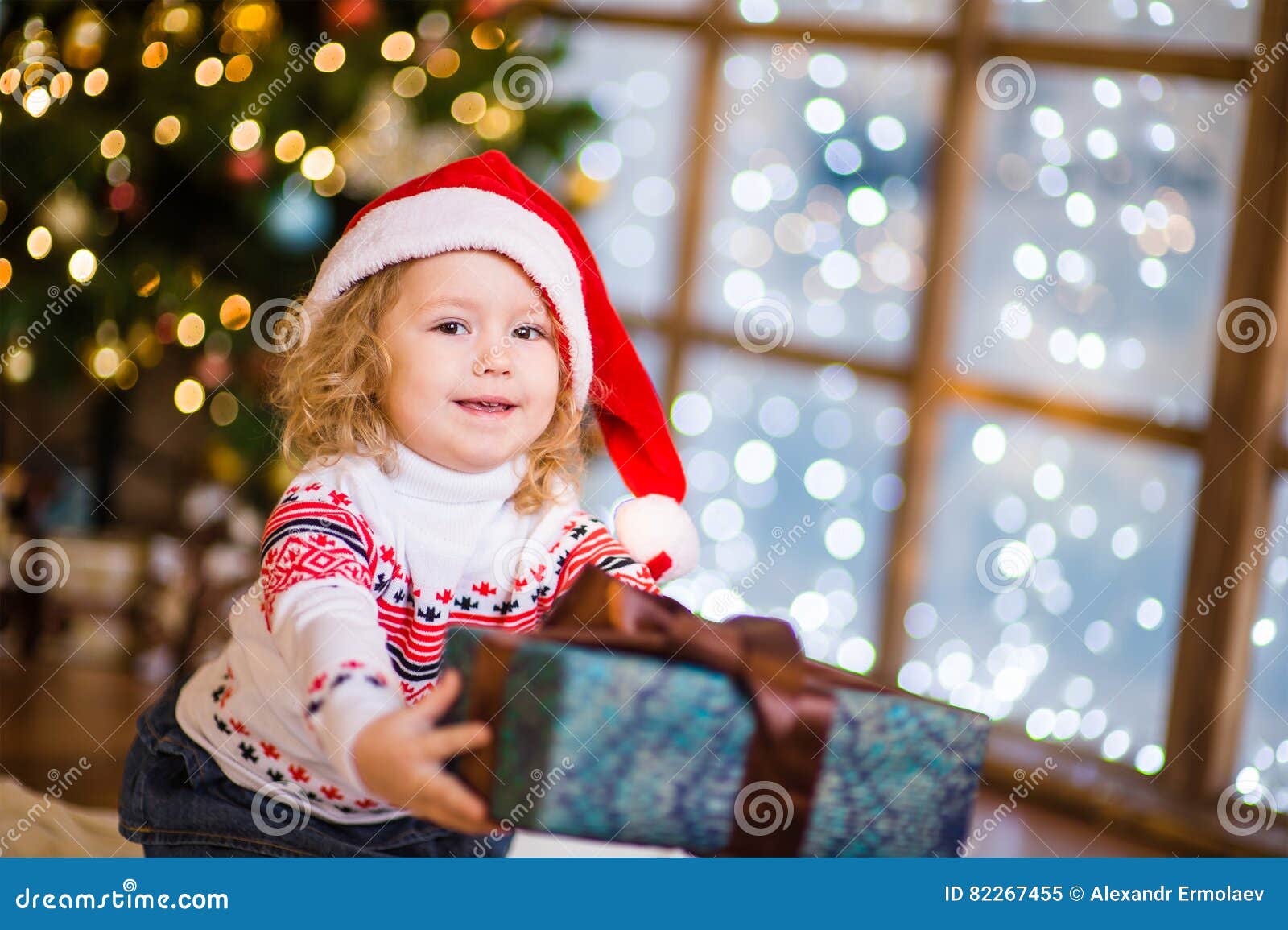Little girl gives a gift stock image. Image of childhood - 82267455