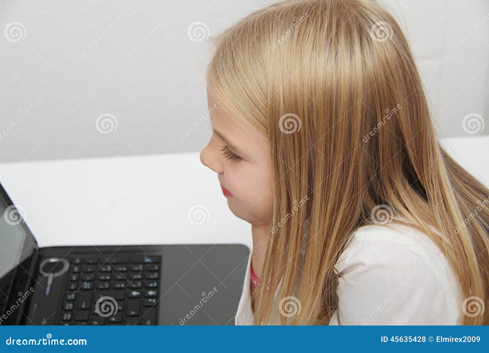 Little Girl with Her Computer at Home at the Table Stock Photo - Image ...