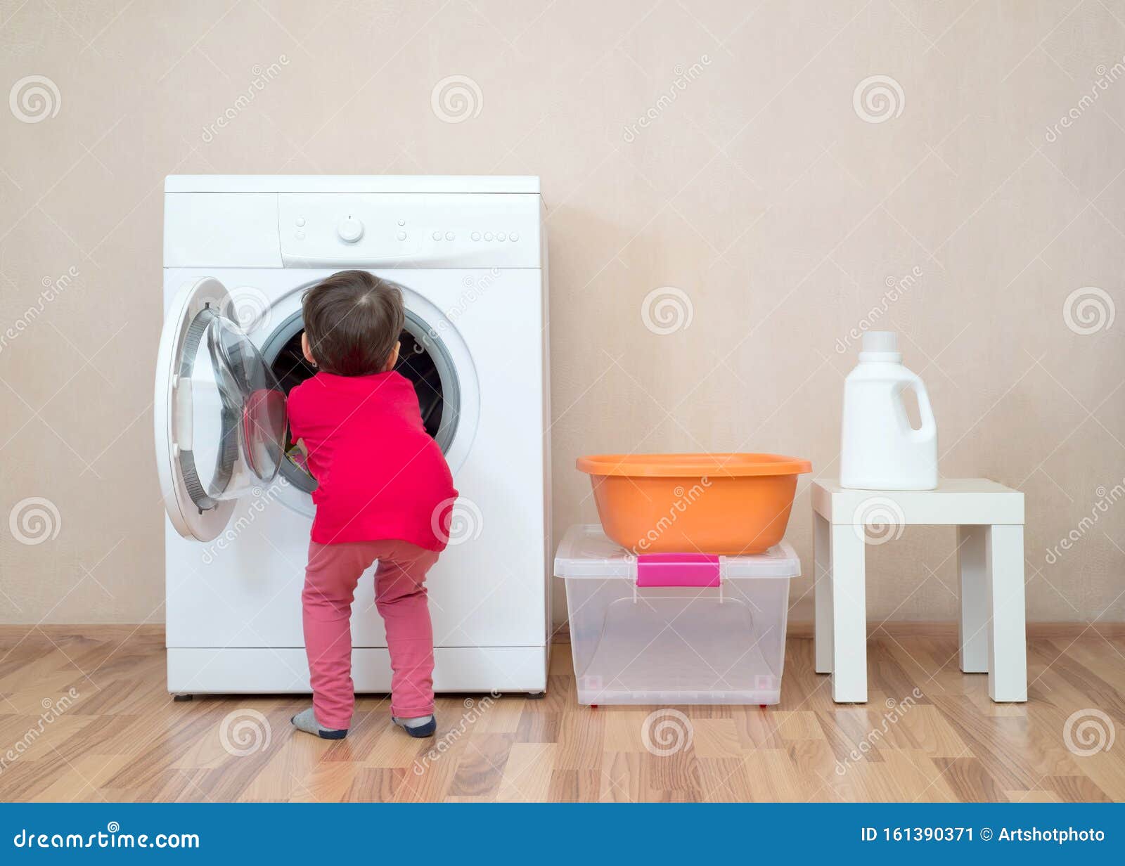 Little Girl with Her Hands Inside a Washing Machine Stock Image - Image ...