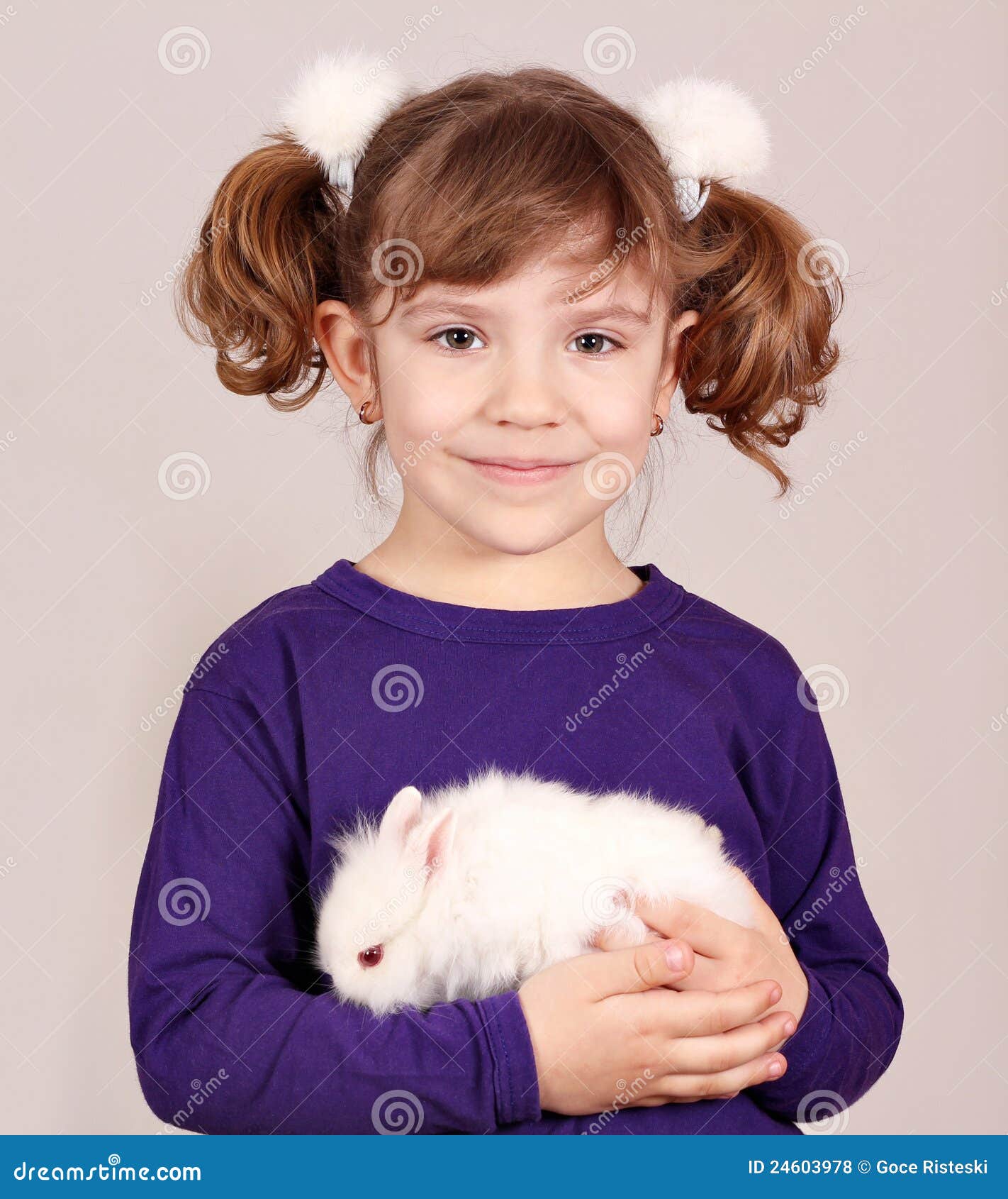 Little Girl Holding Dwarf Bunny Stock Photo | CartoonDealer.com #24603978