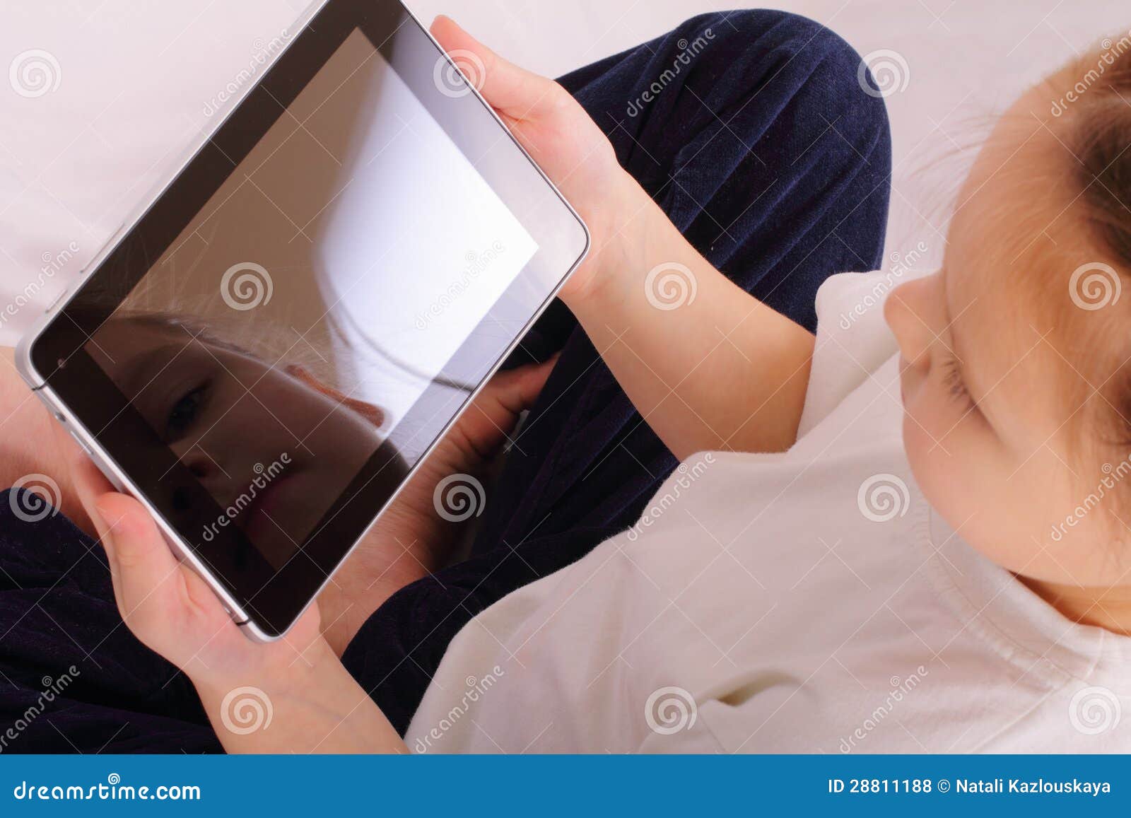 Little girl holding ipad stock photo. Image of device - 28811188