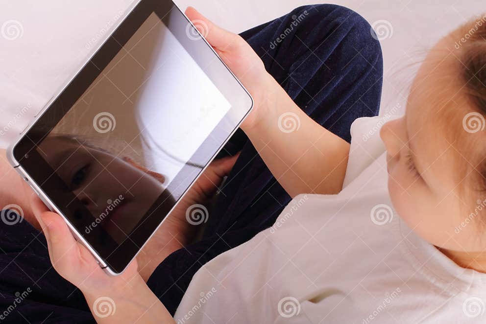 Little girl holding ipad stock photo. Image of device - 28811188