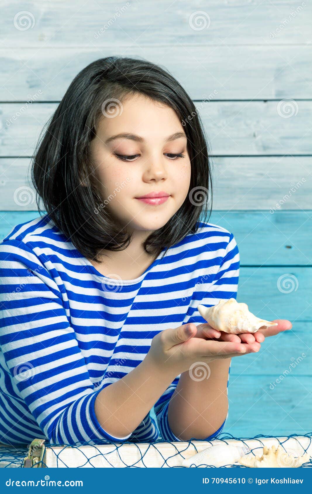Little Girl Holding a Shell Stock Photo - Image of tour, vest: 70945610