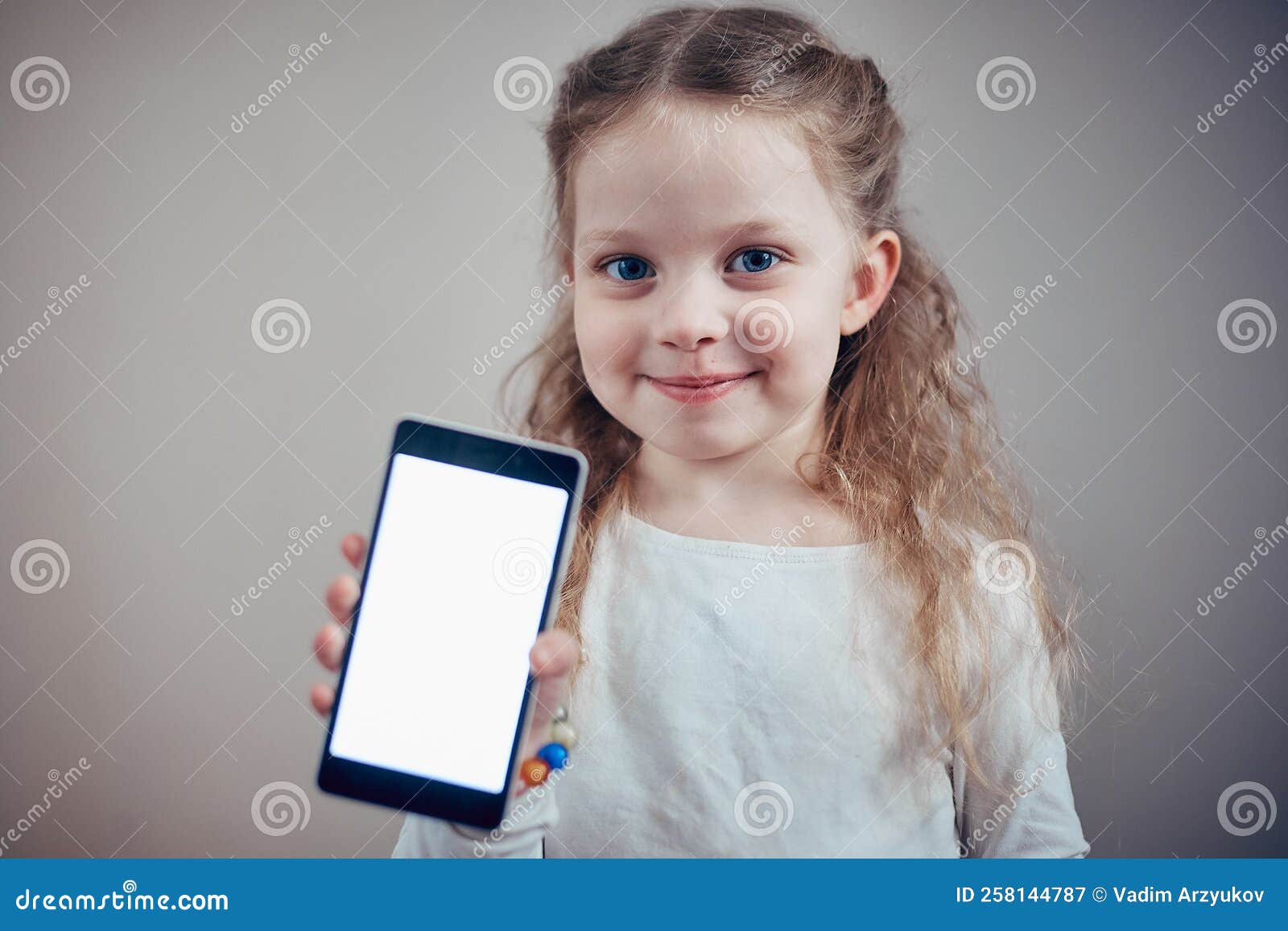 Little Girl Holding a Smartphone with a White Screen Stock Image ...