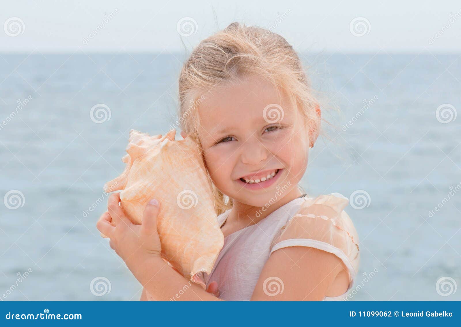 Little girl holds a shell stock photo. Image of blond - 11099062