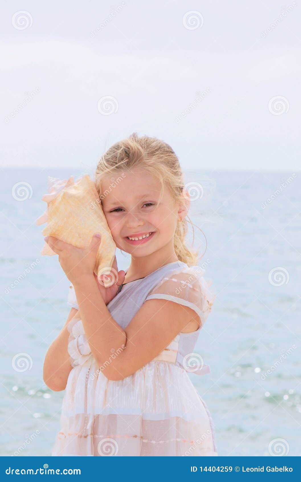 Little girl holds a shell stock image. Image of caribbean - 14404259