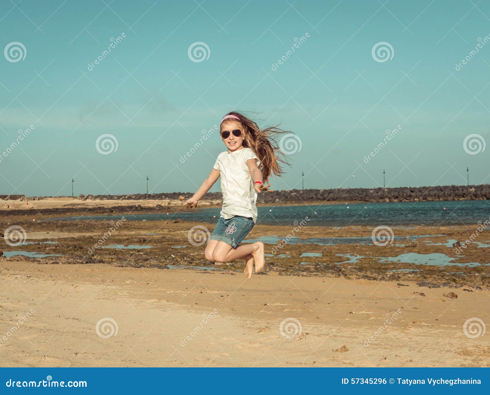 Little Girl Jump on a Beach Stock Photo - Image of jump, beautiful ...