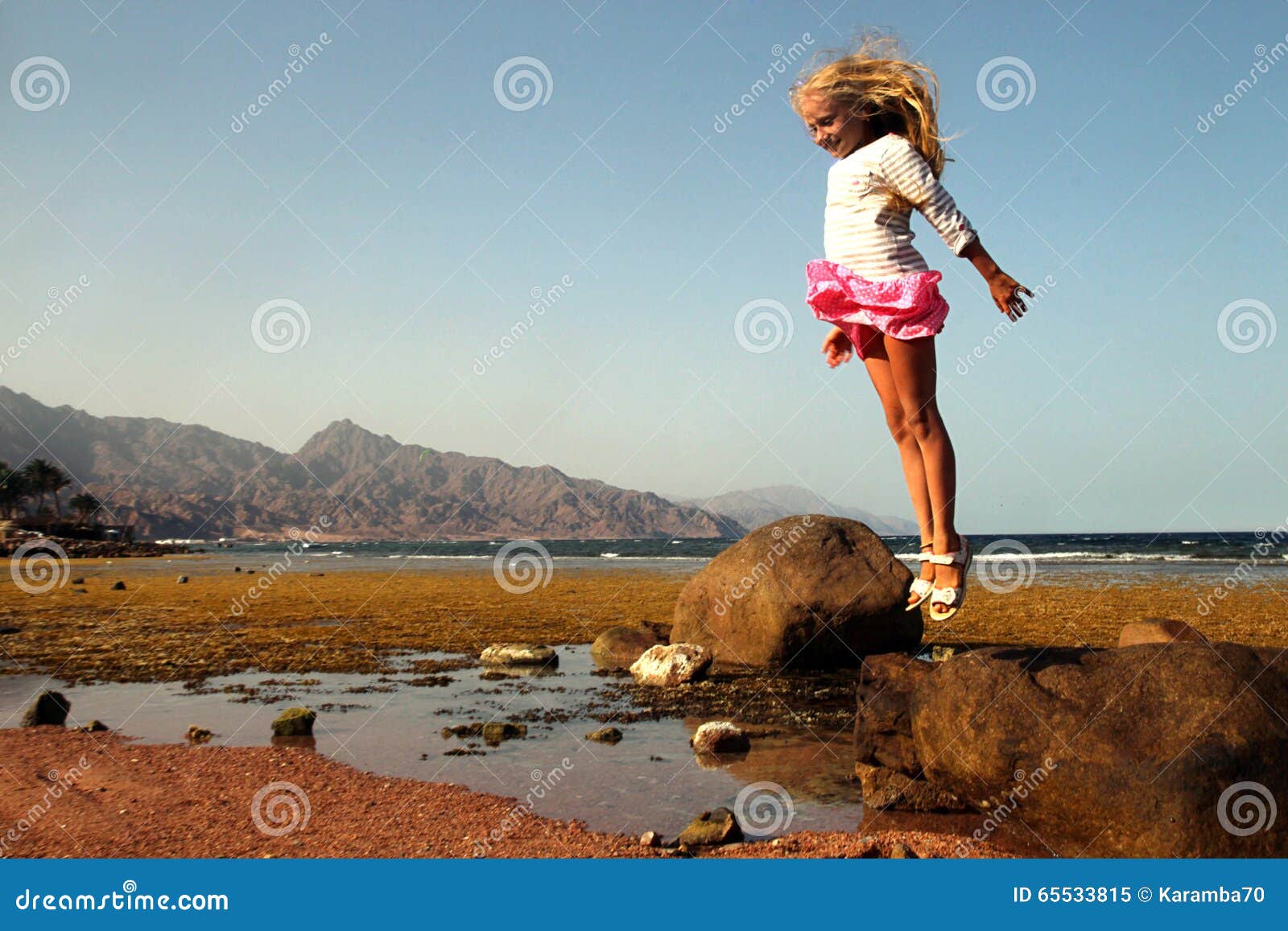 Jumping Stone In Water And Foot Trails In Beach Sand. The Coastline In ...
