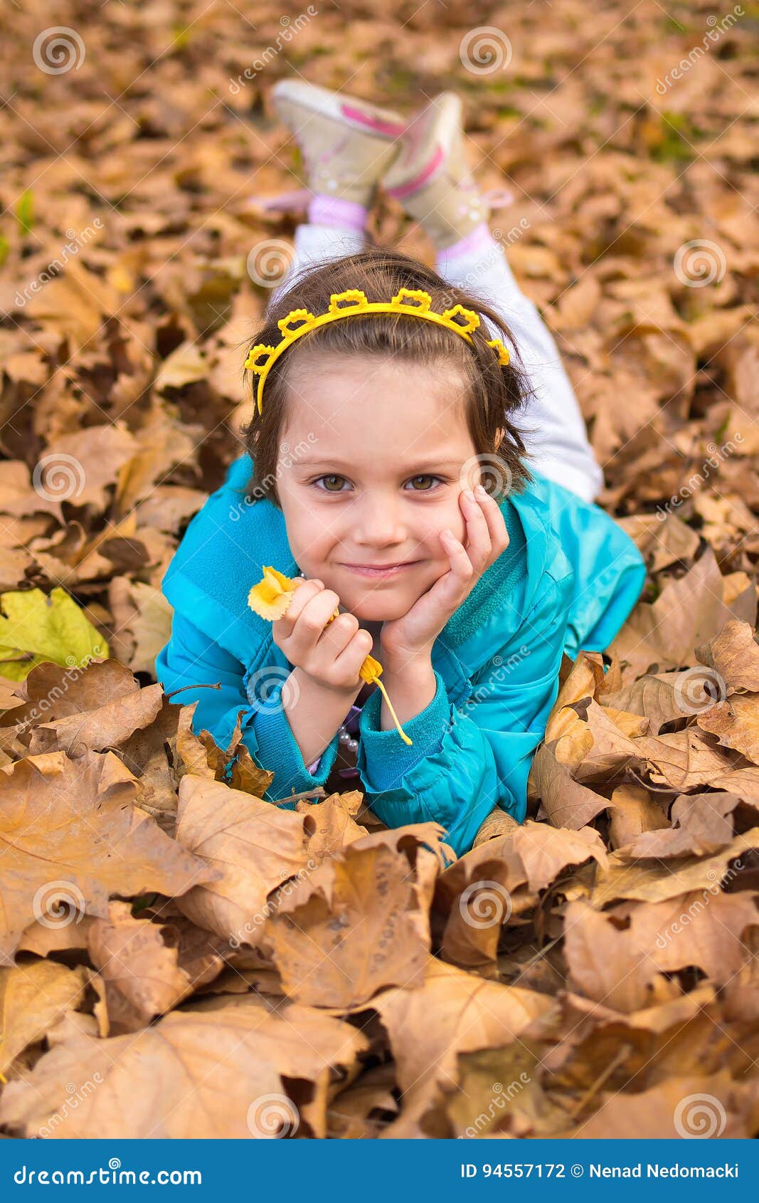 Little Girl Laying with Face on Hands in Park Stock Photo - Image of ...