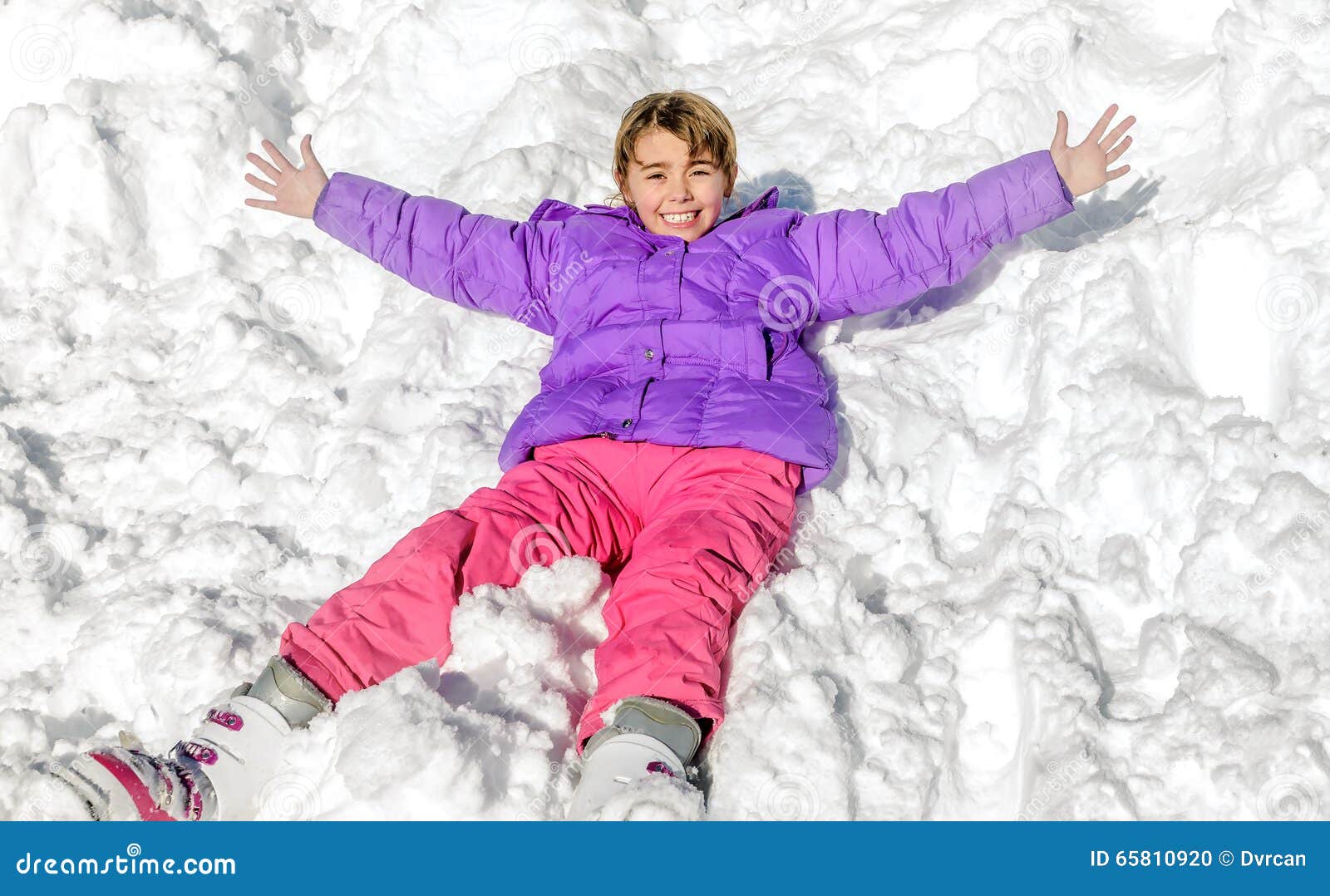 Little Girl Laying on the Snow Stock Photo - Image of girl, happy: 65810920