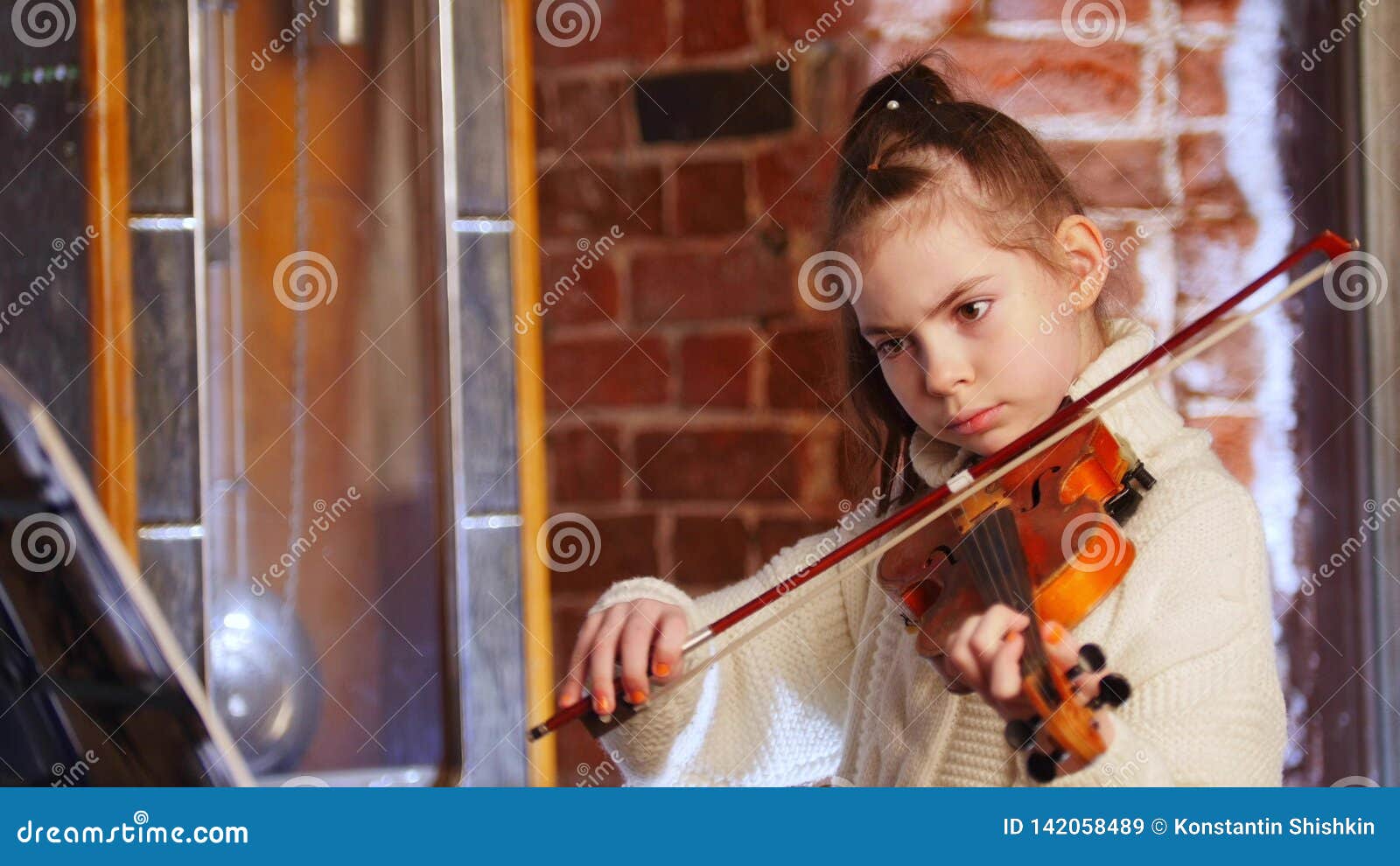 A Little Girl Learning a Composition by Notes Stock Image - Image of ...