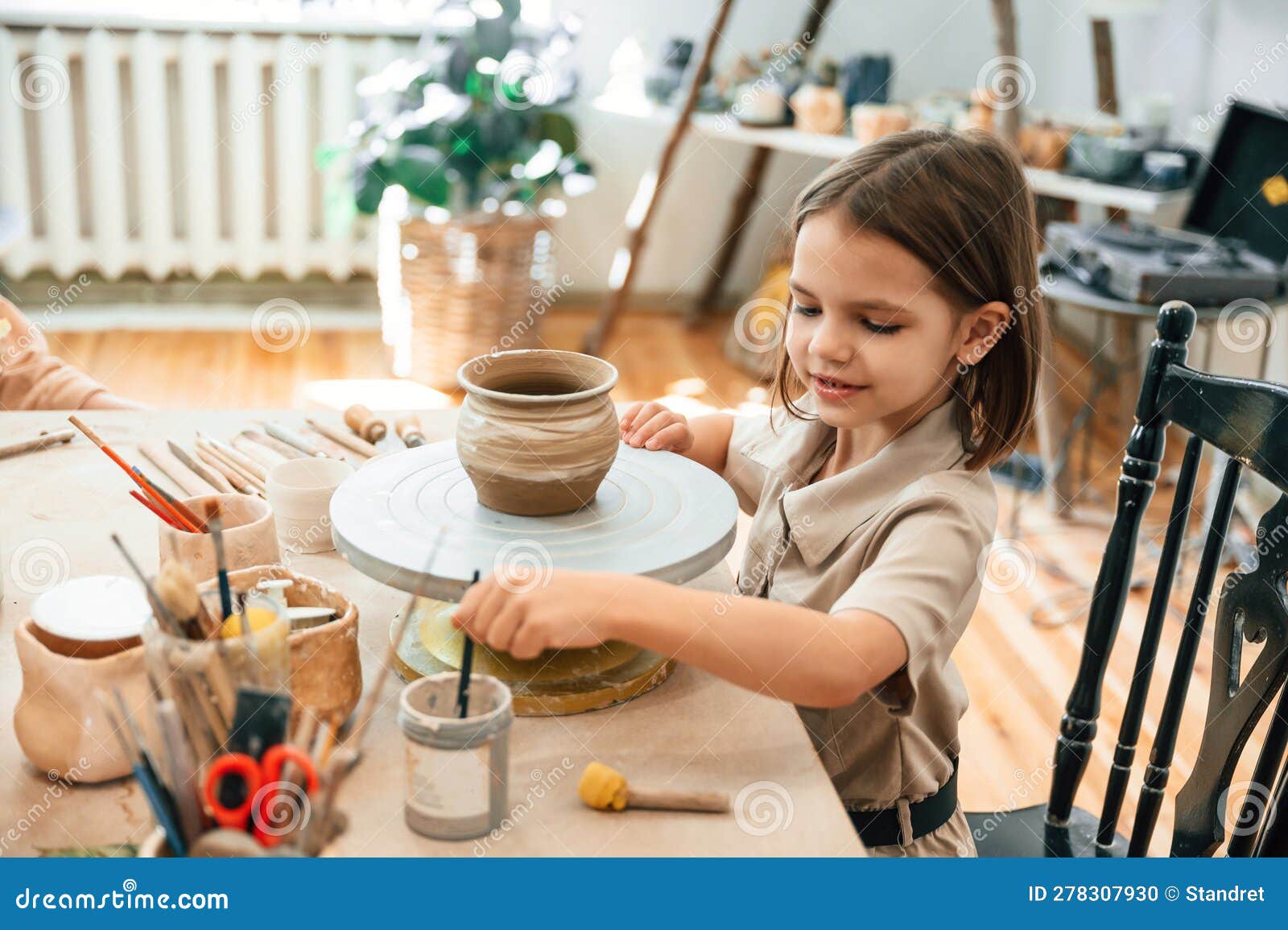 Little Girl is Learning How To Do Pottery in the Workshop Stock Photo ...