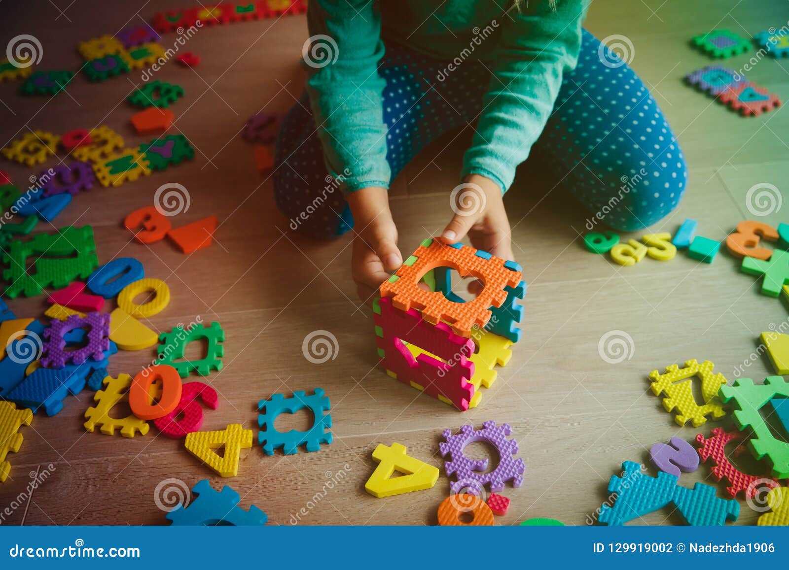 Little Girl Learning Numbers Play With Puzzle Picture. Image: 129919002