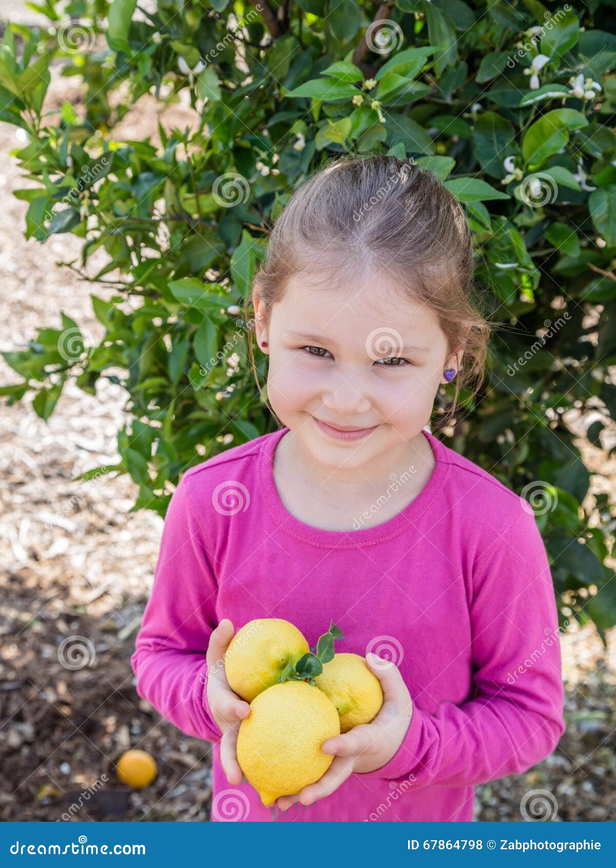 Little girl with lemon stock photo. Image of america - 67864798