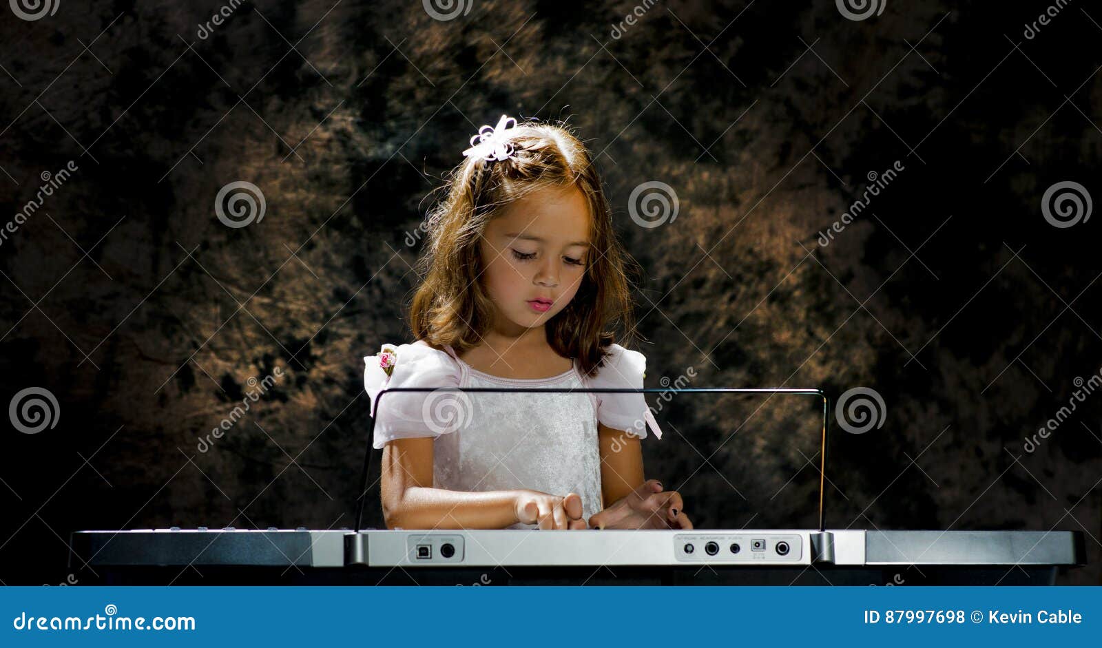 Little Girl Looking Down at Keyboard Stock Photo - Image of music ...