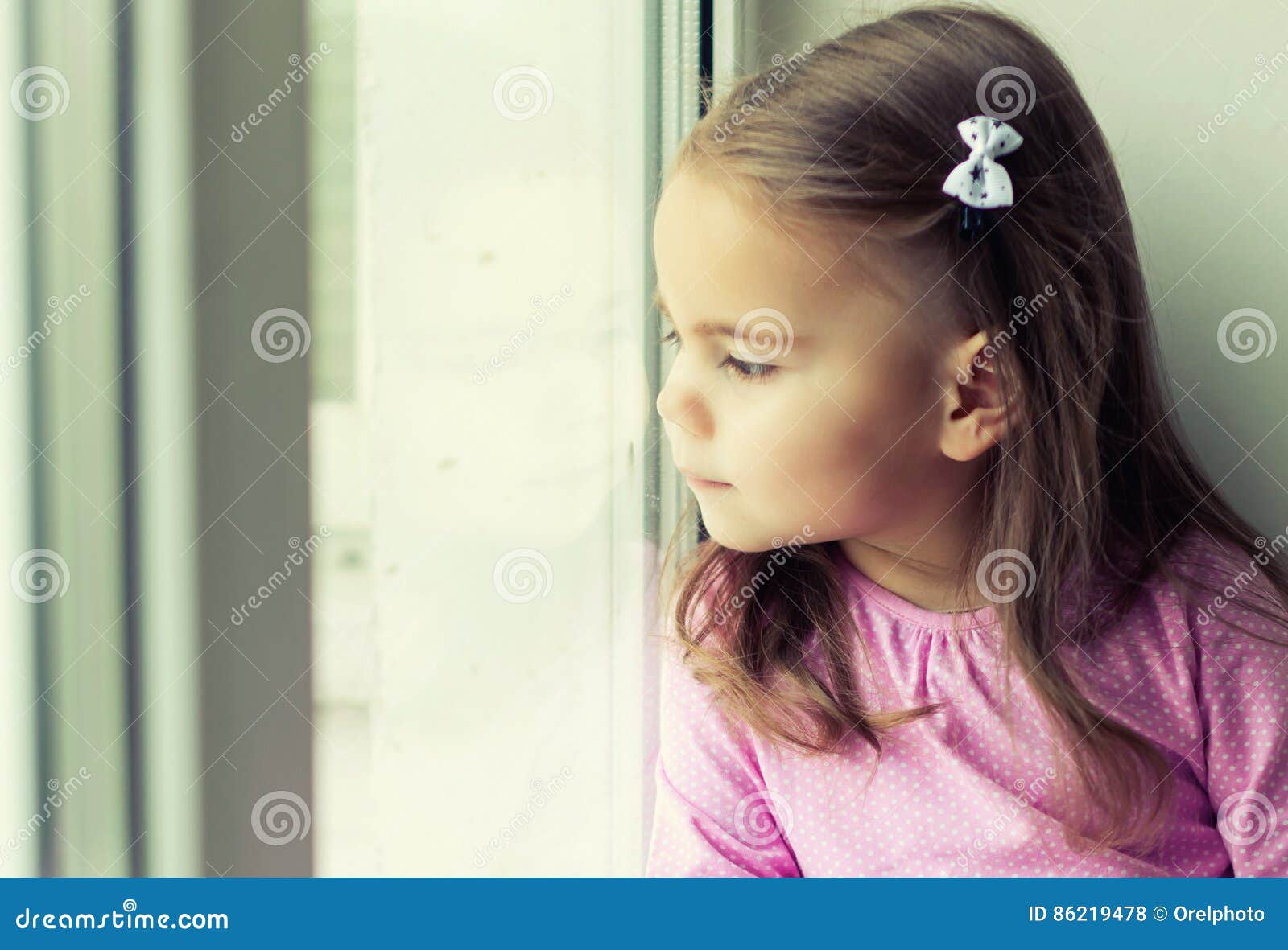 Little Girl Looking through the Window Stock Photo - Image of hair ...