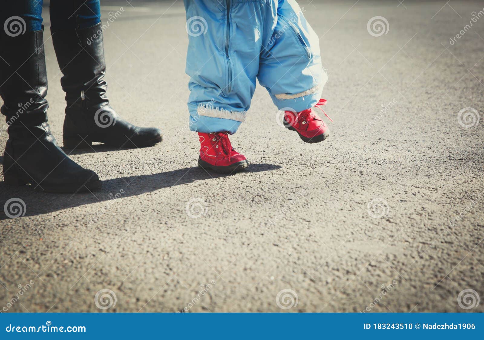 Little Girl Making First Steps with Mothers Help Stock Photo - Image of ...