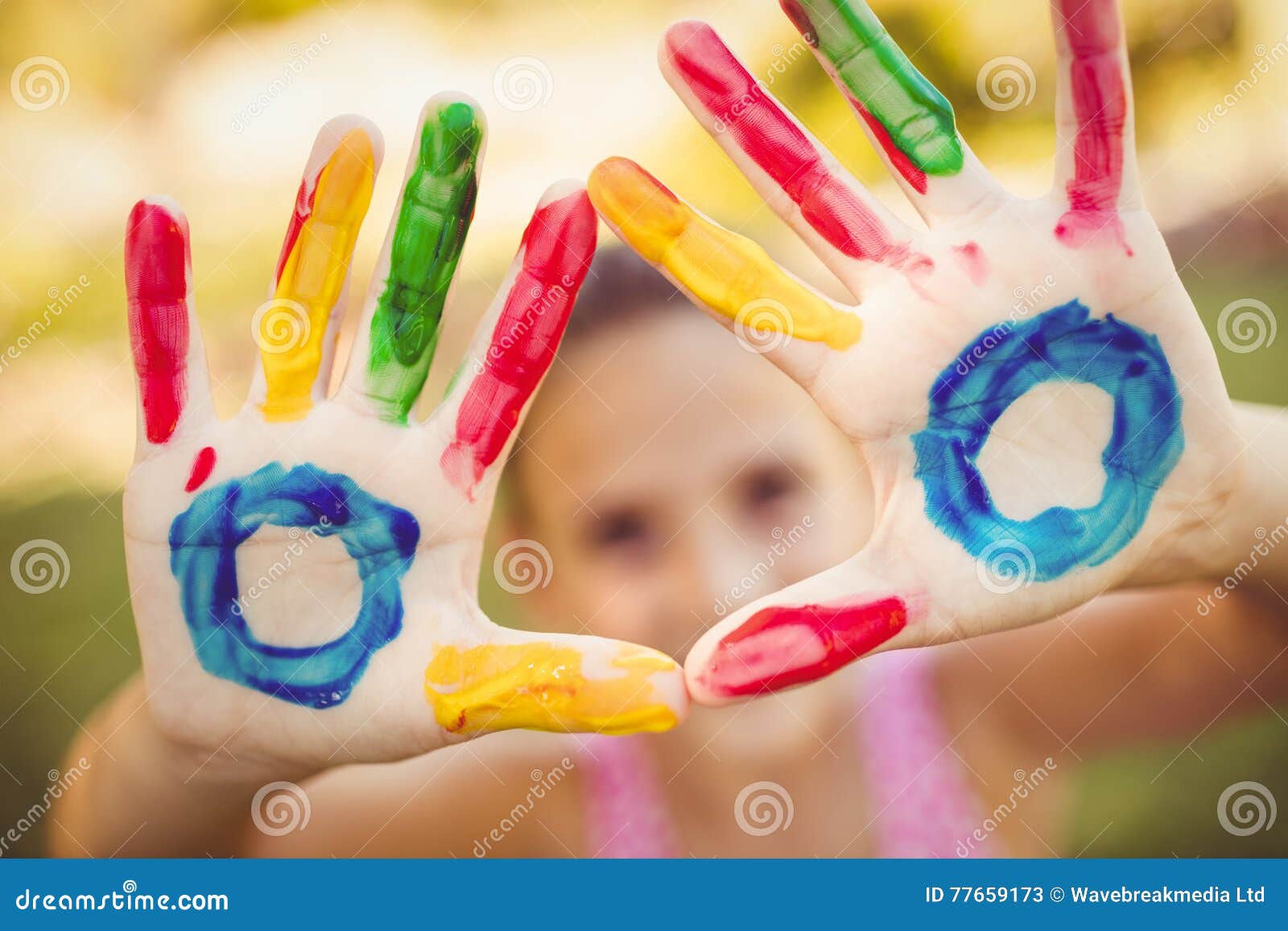 Little Girl Making a Triangle with Her Painted Hands To the Camera ...