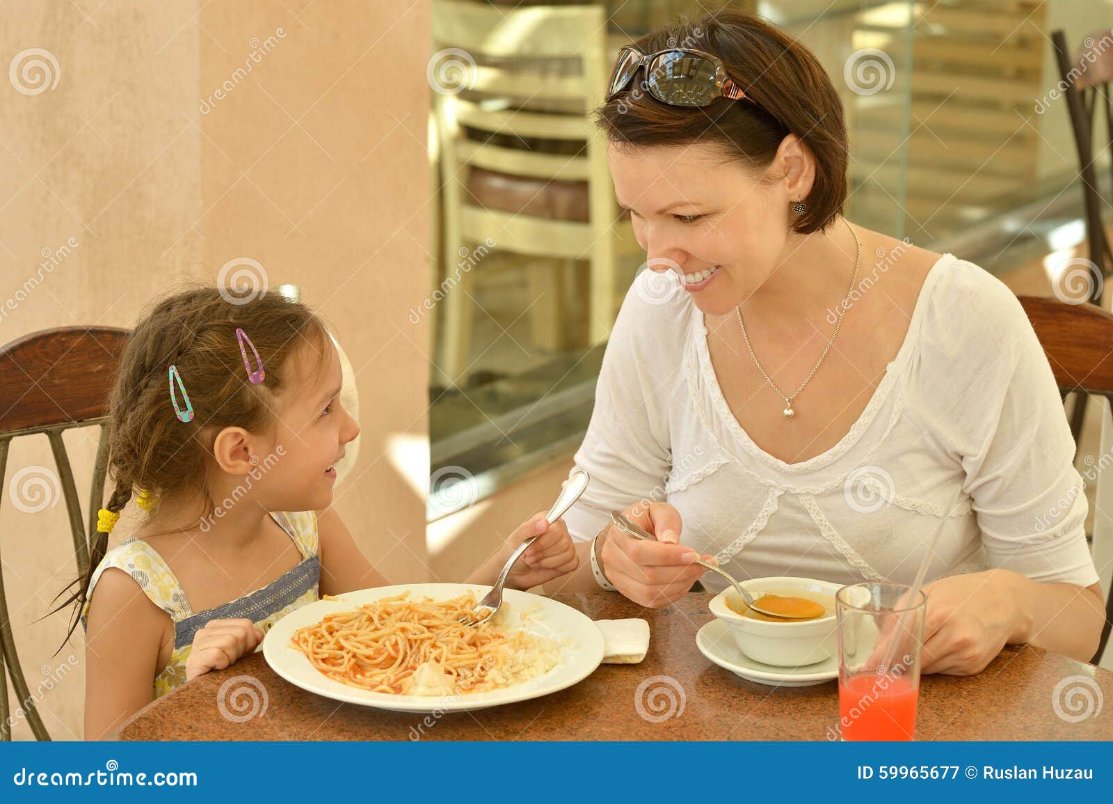 Little Girl with Mother Eats Stock Image - Image of caucasian, girl ...