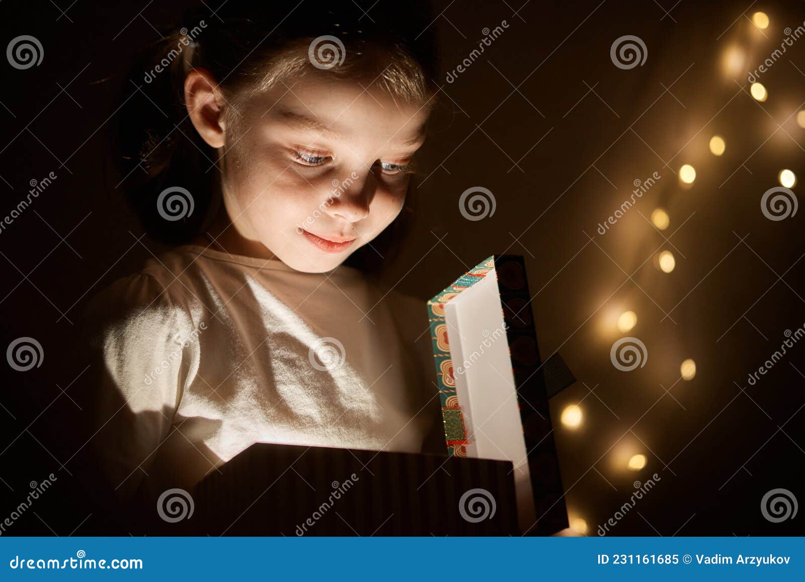 A Little Girl Opens a Glowing Gift Box Stock Image - Image of magic ...