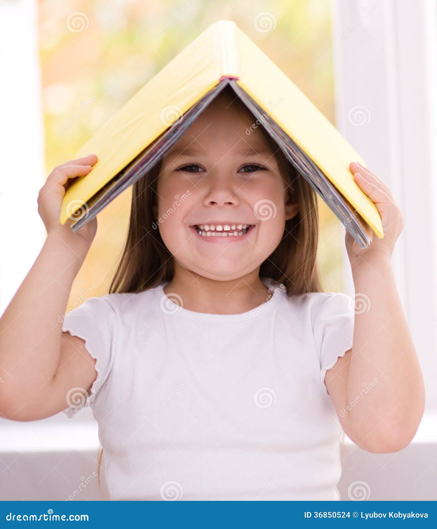 Little Girl is Playing with Book Stock Photo - Image of brunette ...