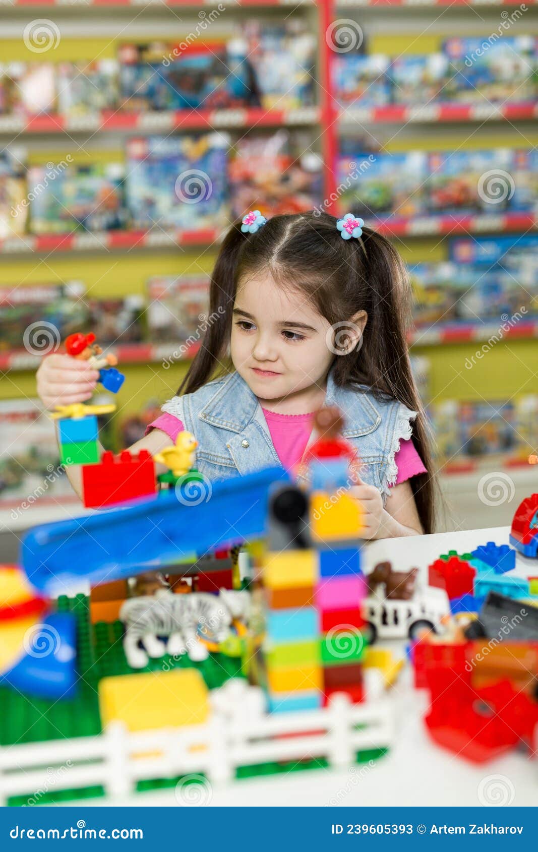 Little Girl Playing with Building Blocks in the Store. Stock Image ...