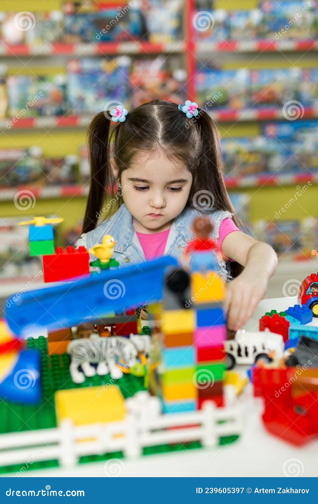 Little Girl Playing with Building Blocks in the Store. Stock Image ...