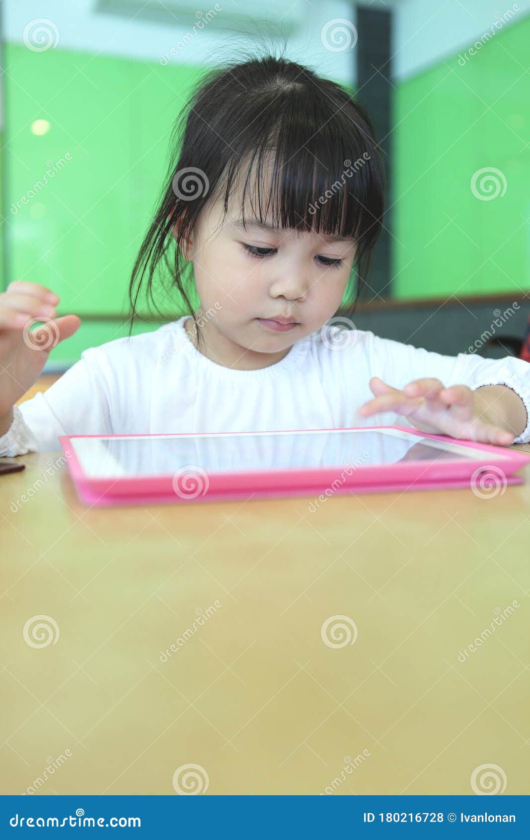 Little Girl Playing Computer Tablet on the Table Stock Photo - Image of ...