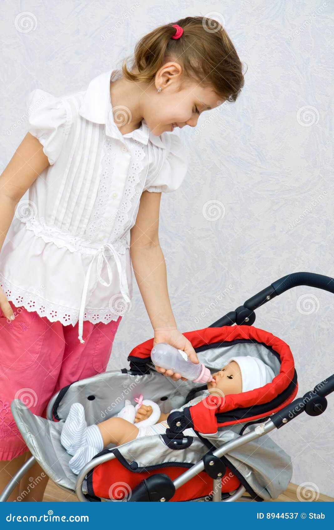 Little Girl Playing with Doll Stock Image - Image of attractive, bottle ...