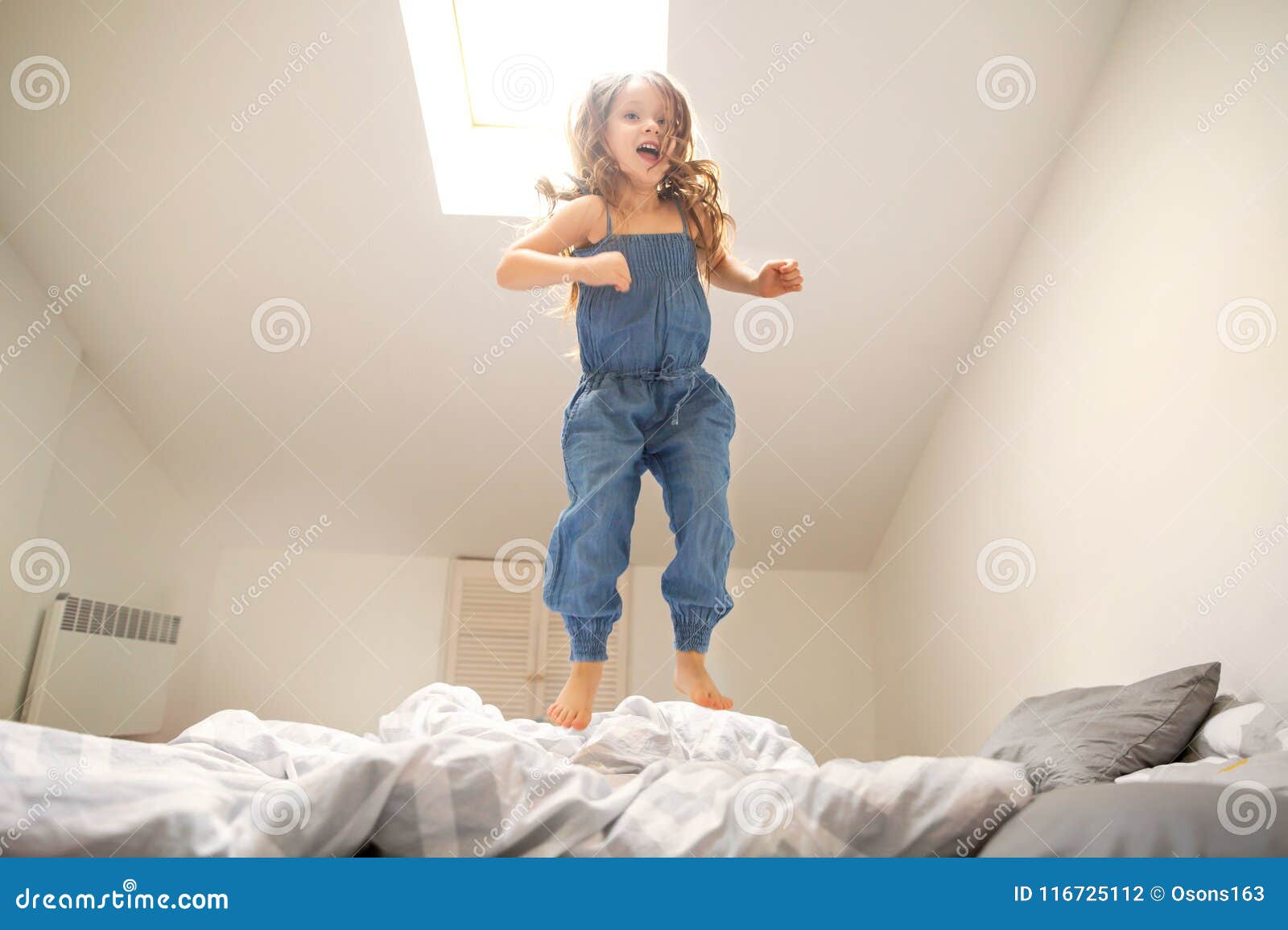 Little Girl Playing and Jumping at Home Stock Photo - Image of book ...