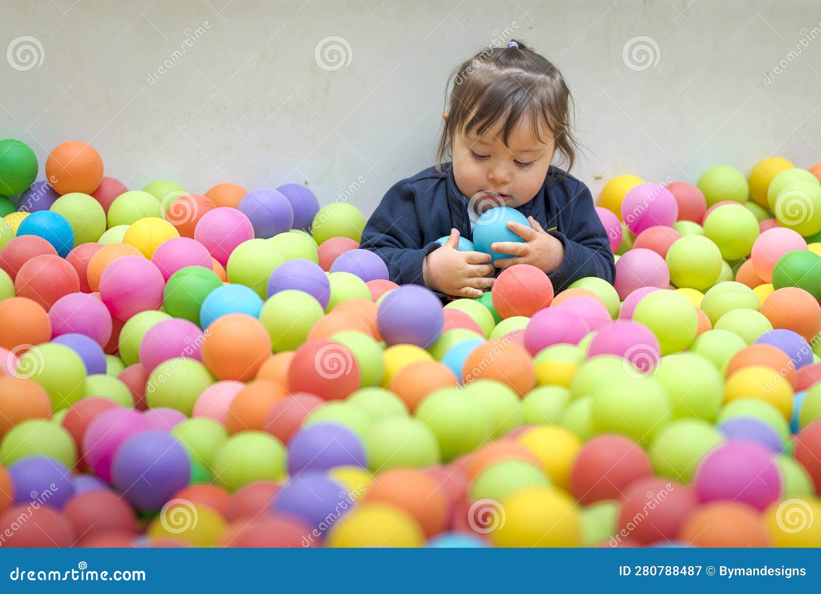 The Little Girl Playing in a Pool with Colored Balls Stock Image ...