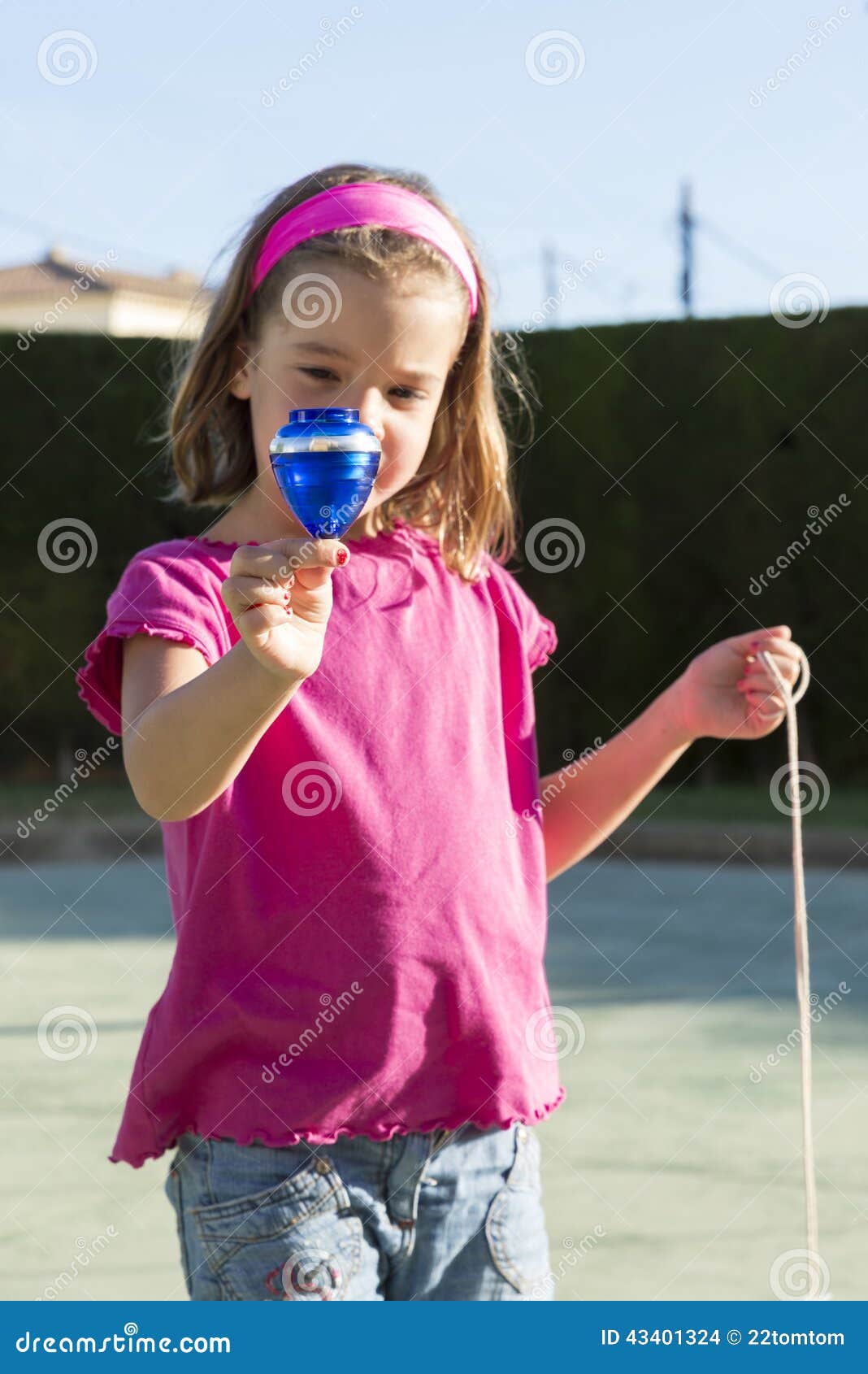 Little Girl Playing with a Spinning Top Stock Photo - Image of activity ...