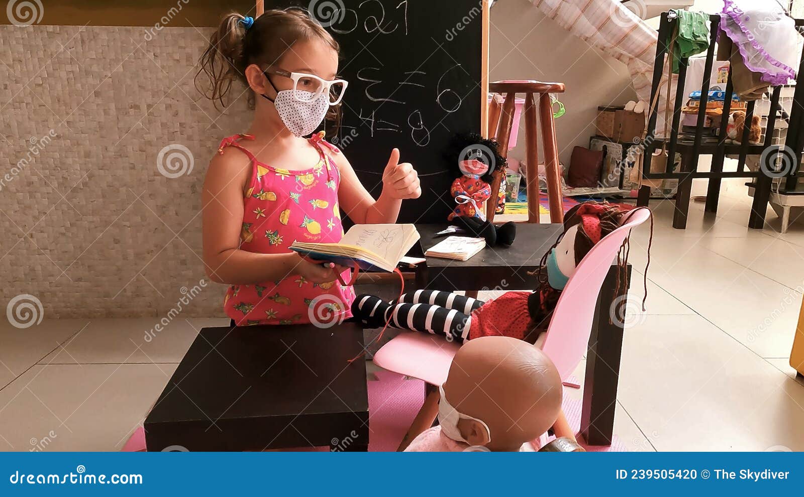 Little Girl Playing Teacher, Teaching Her Dolls with a Mask. Stock ...